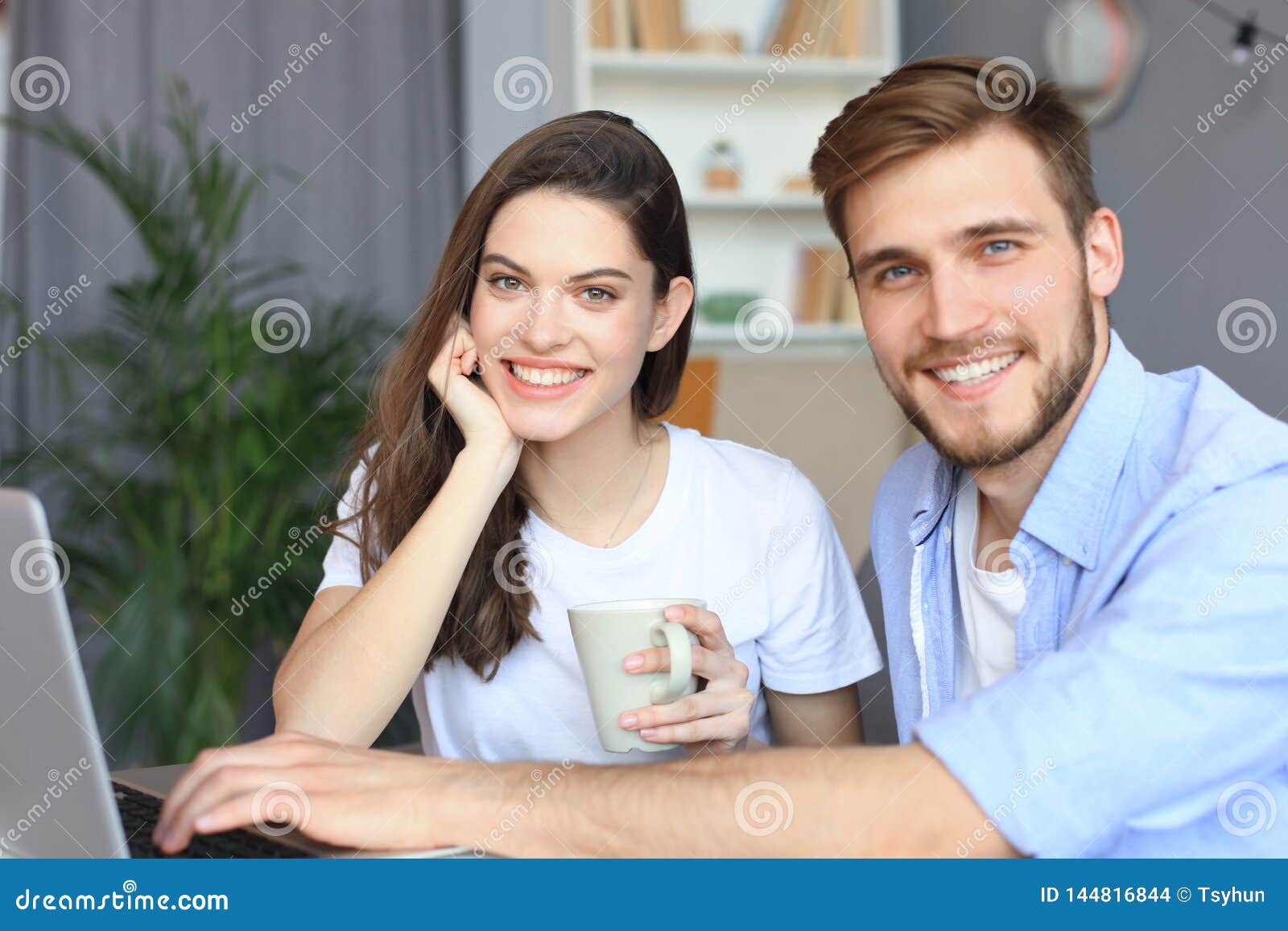 Couple Pointing while Working Together on Laptop. Stock Photo - Image ...