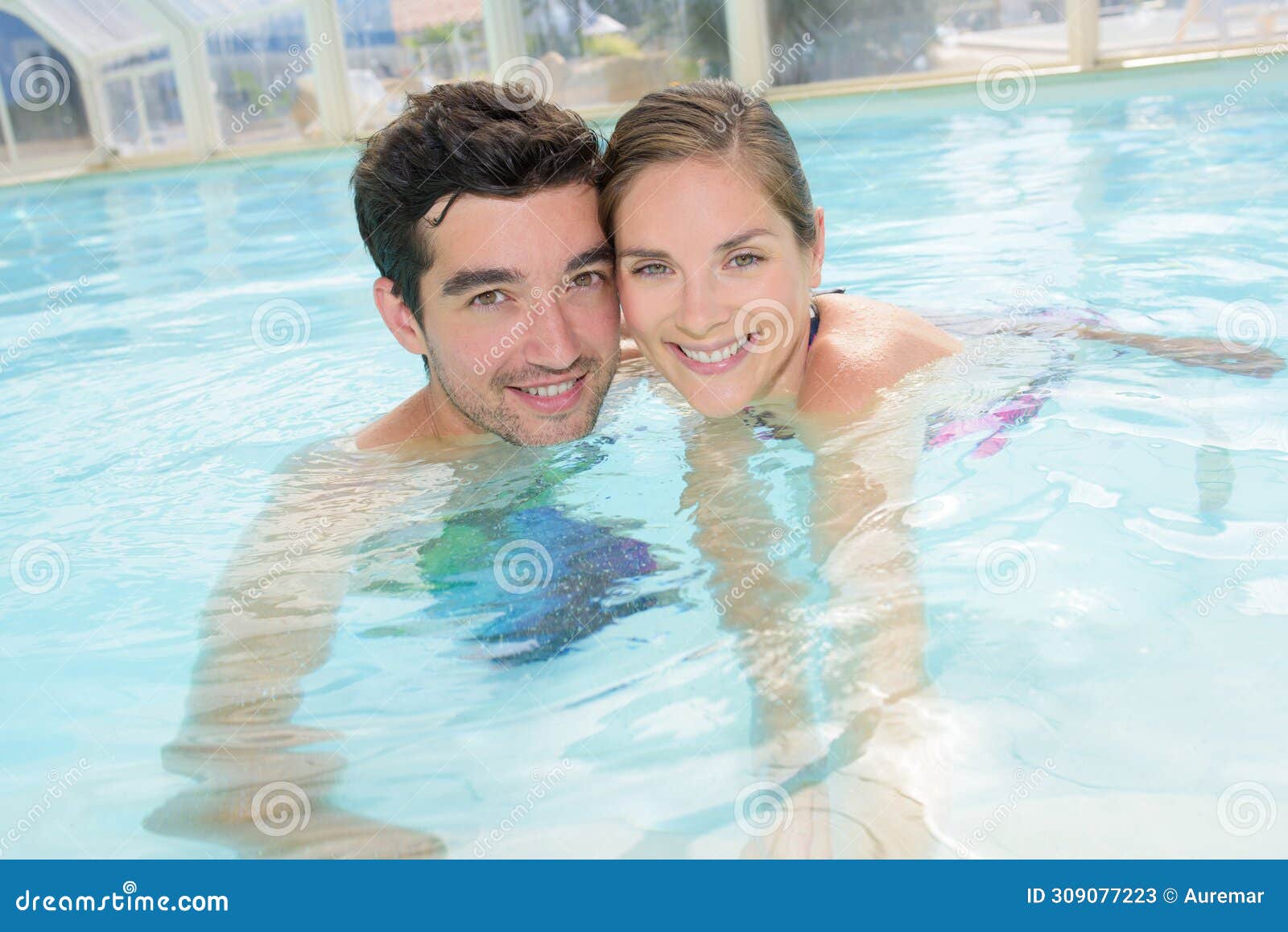 Couple posing in pool stock image. Image of pose, heated - 309077223