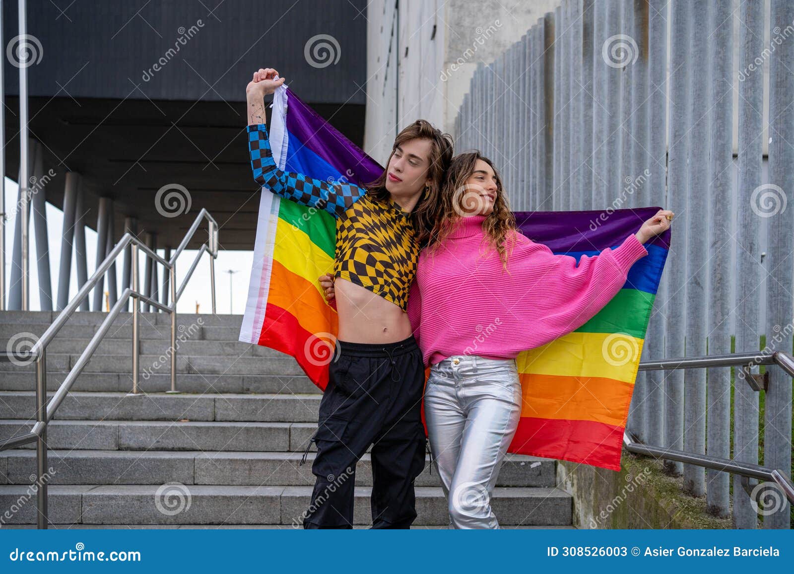 Couple Posing with Pride Flag in Front of Stairs Dressed in Brightly ...