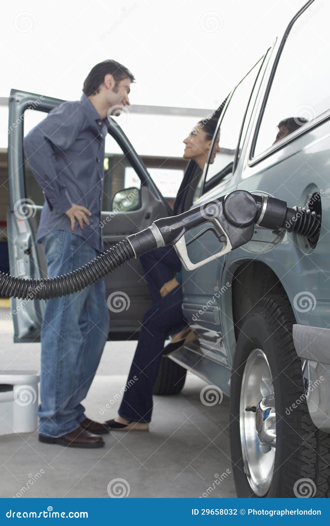 Couple Pumping Gas into Car Stock Photo - Image of couple, lifestyle ...
