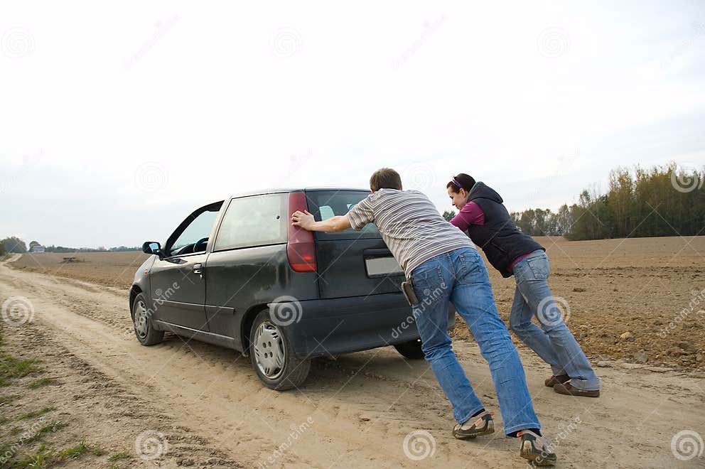 Couple pushing a car stock photo. Image of motor, motoring - 16223132