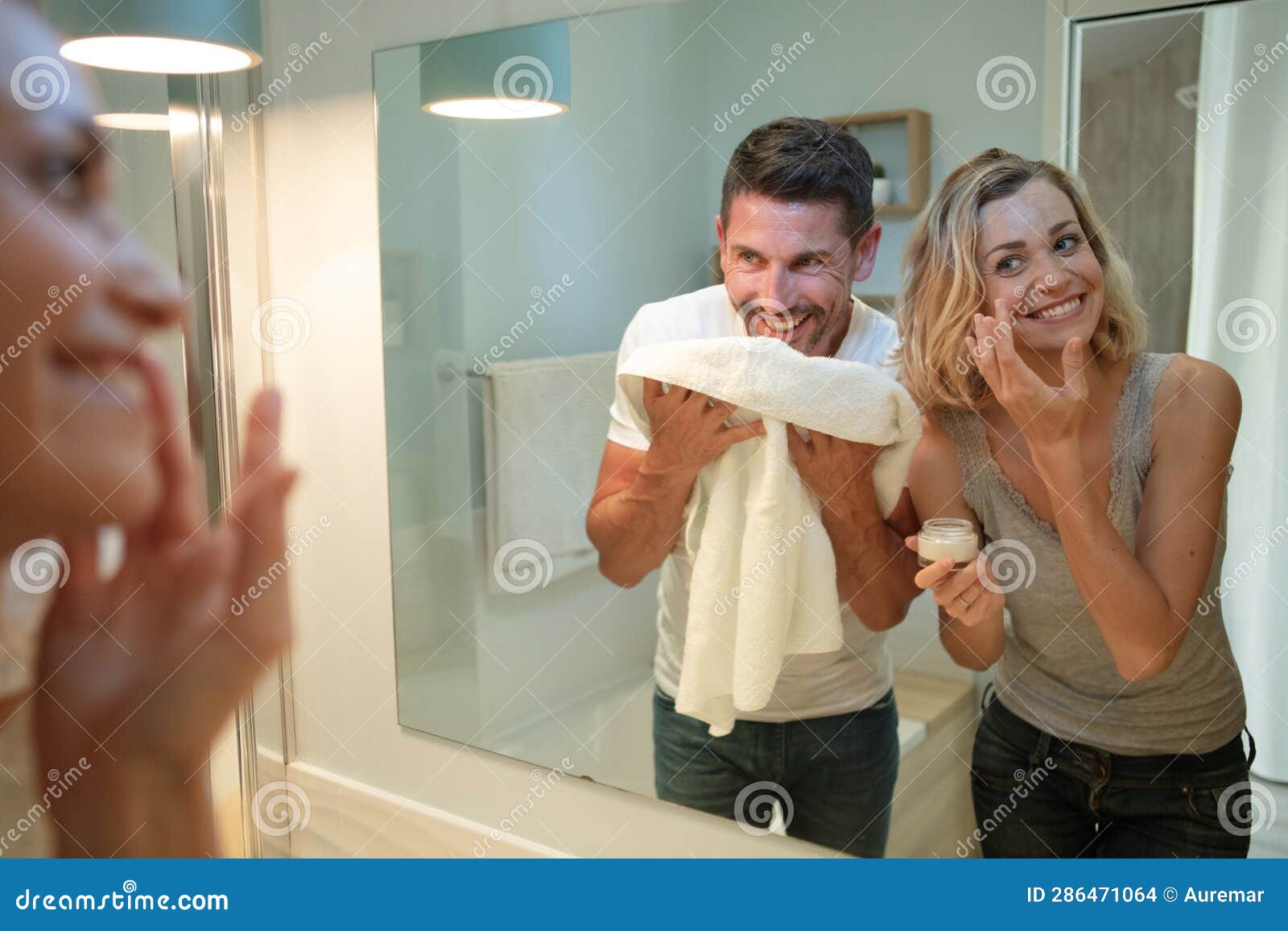 Couple Putting on Face Cream at Home in Bathroom Stock Photo - Image of ...