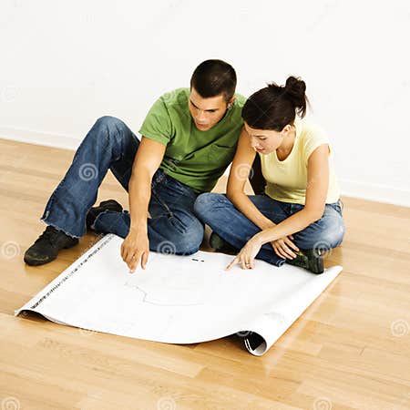 Couple reading blueprints. stock image. Image of looking - 3533021