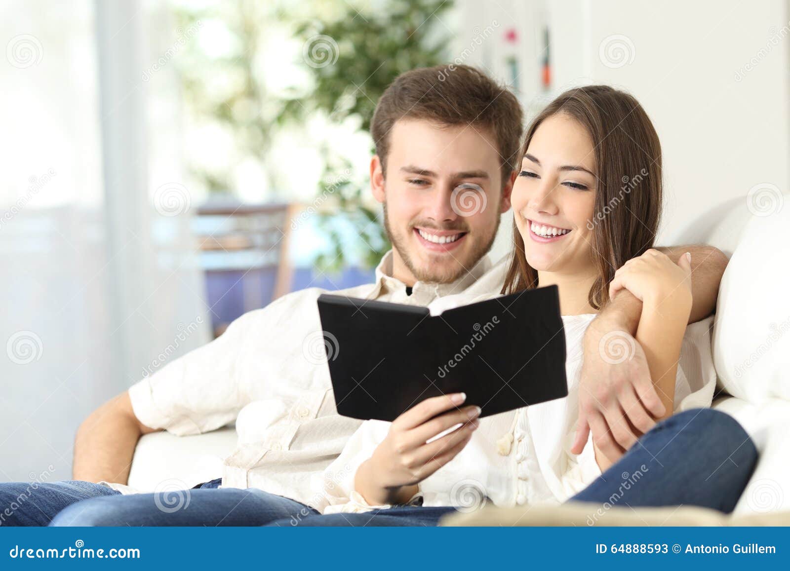 Couple Reading a Guide in an Ebook Stock Image - Image of holding ...