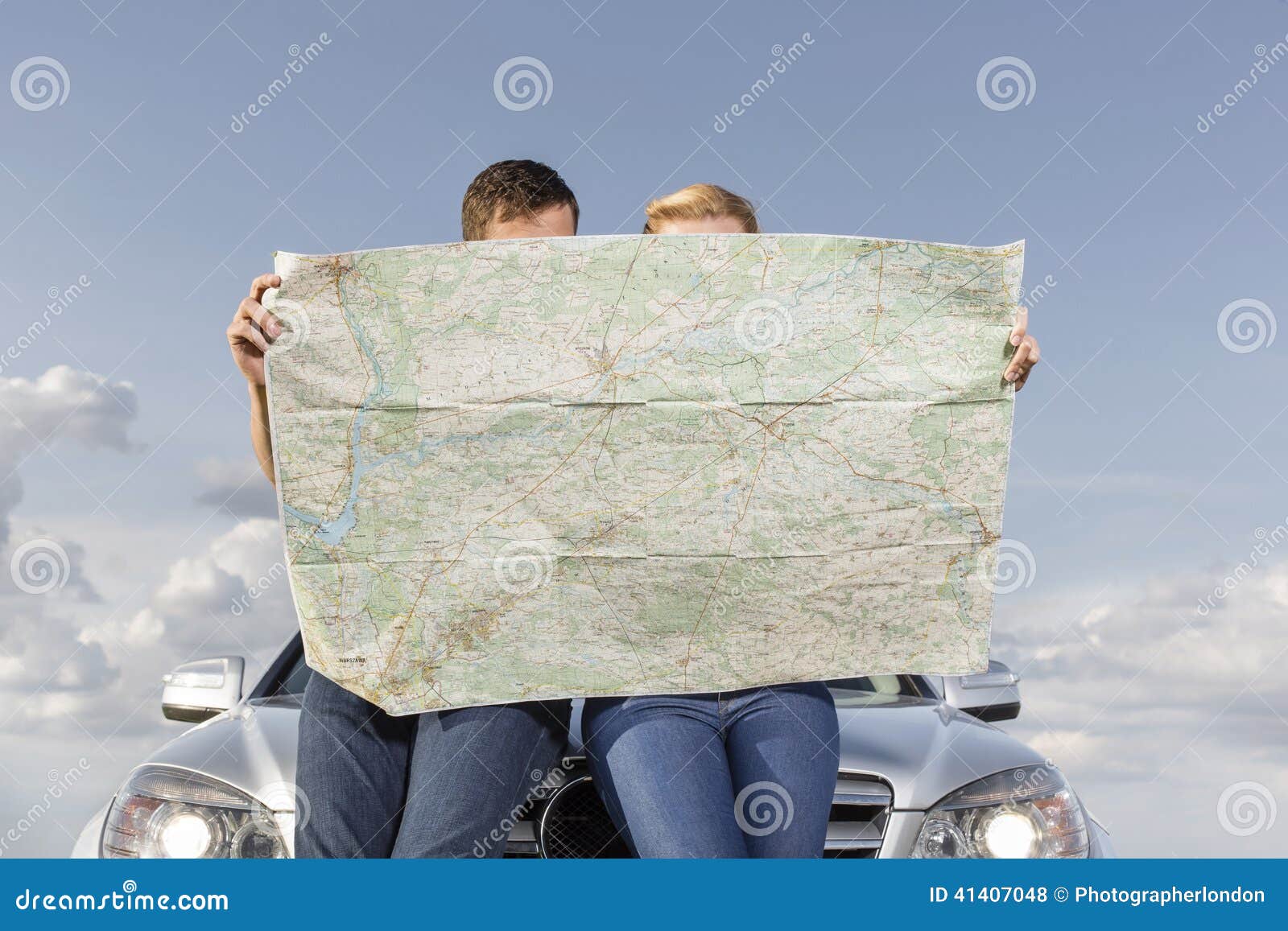 Couple Reading Map while Leaning on Car Hood during Road Trip Stock ...