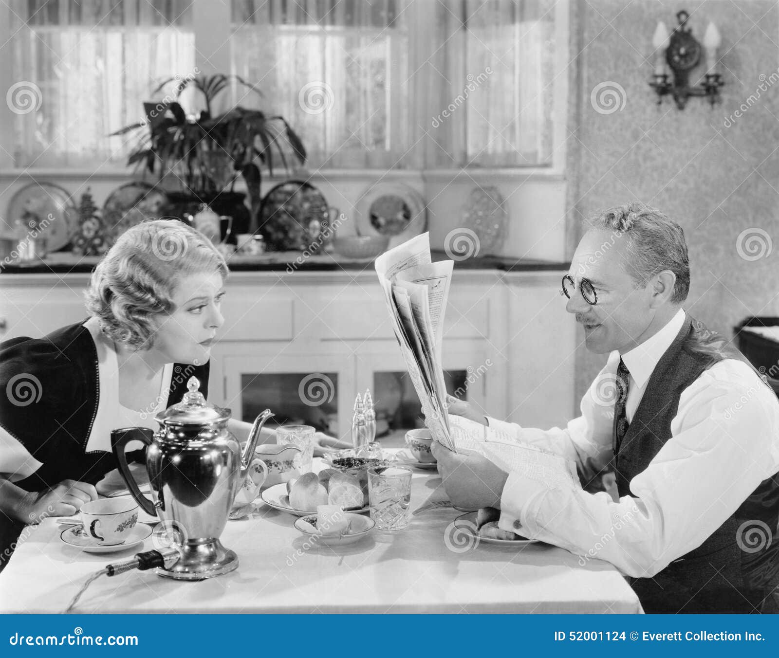 Couple Reading Newspaper at Breakfast Table Stock Photo - Image of ...