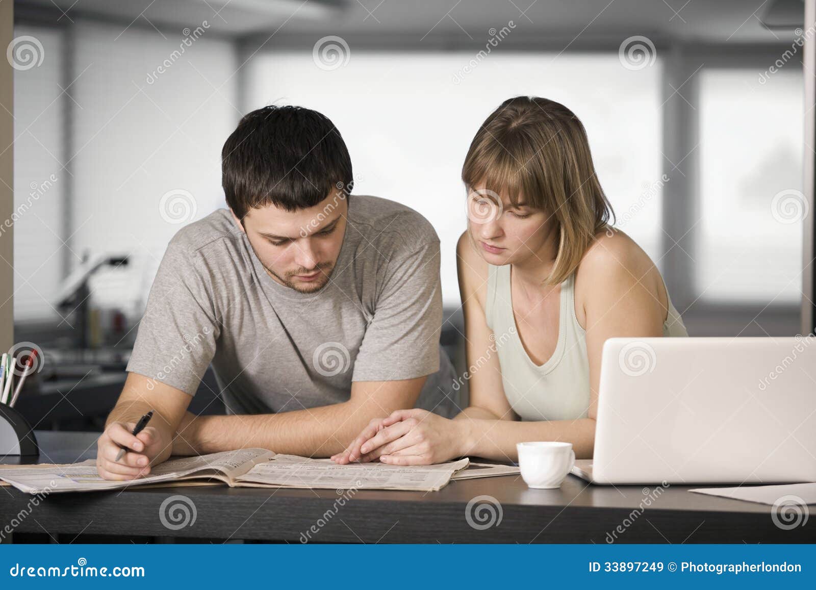 Couple Reading Newspaper Together at Counter Stock Image - Image of ...