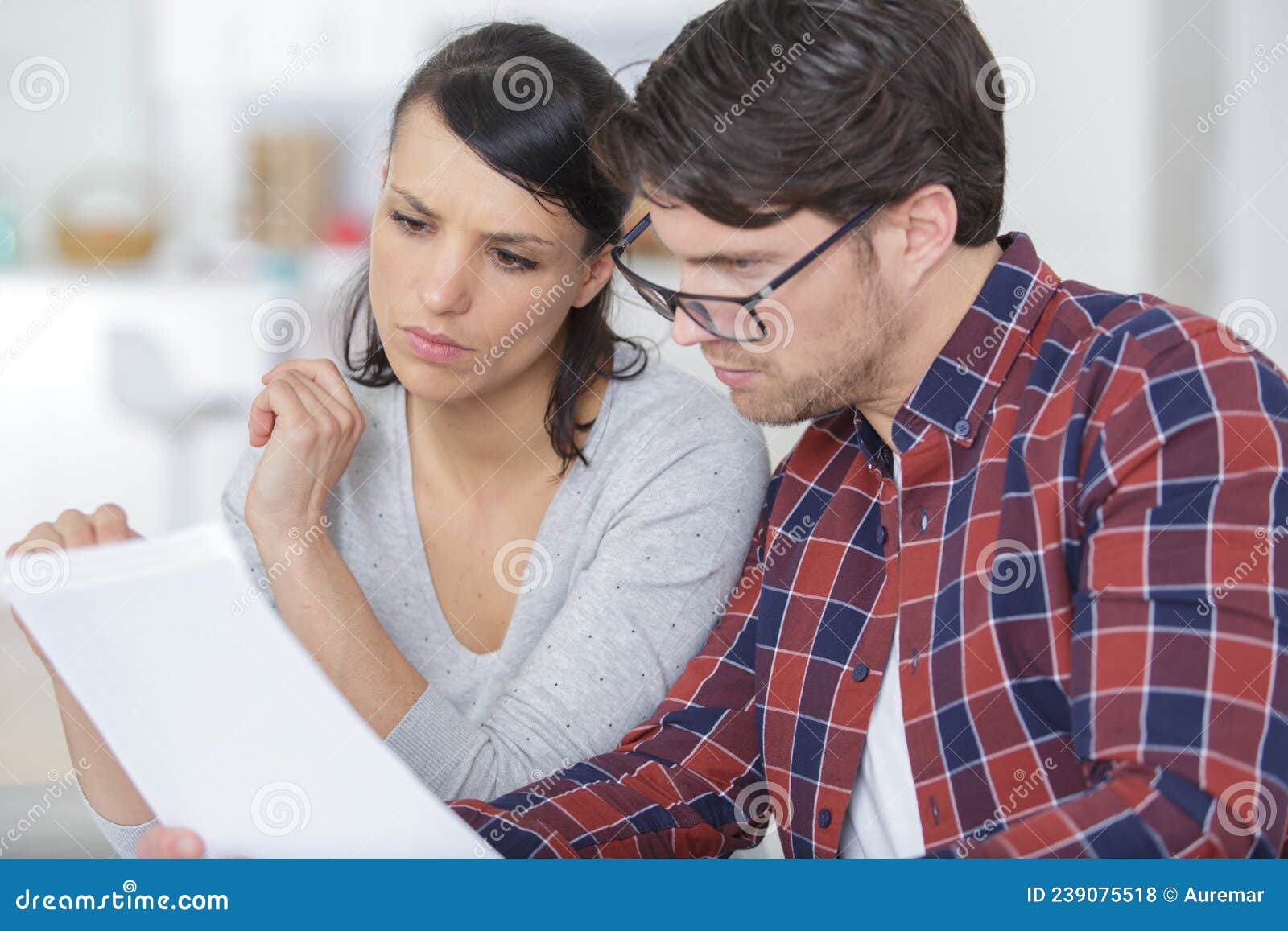 Couple Reading Papers on Couch Stock Photo - Image of communication ...