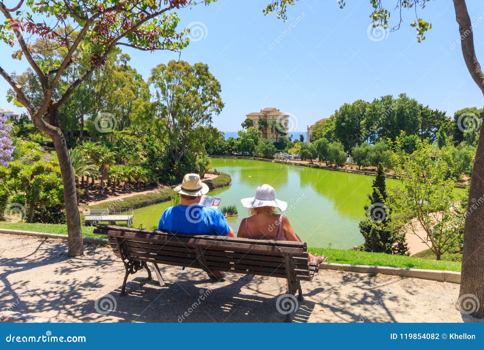 Couple Reading on Park Bench Editorial Photography - Image of view ...