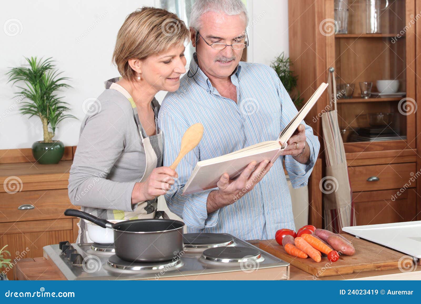 Couple Reading a Recipe Book Stock Image - Image of cookery, good: 24023419
