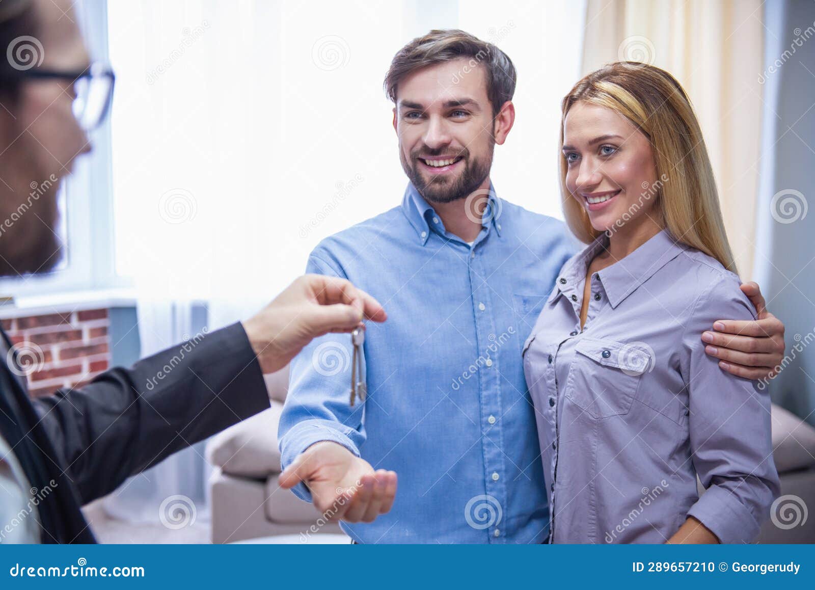 Couple and a realtor stock photo. Image of brokerage - 289657210