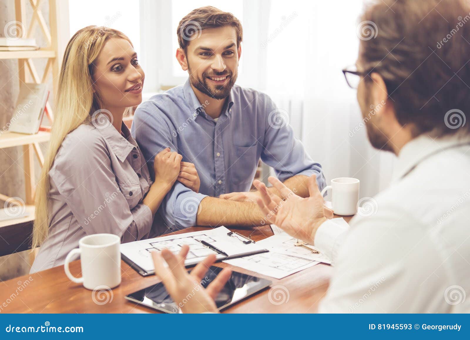 Couple and a realtor stock image. Image of apartment - 81945593