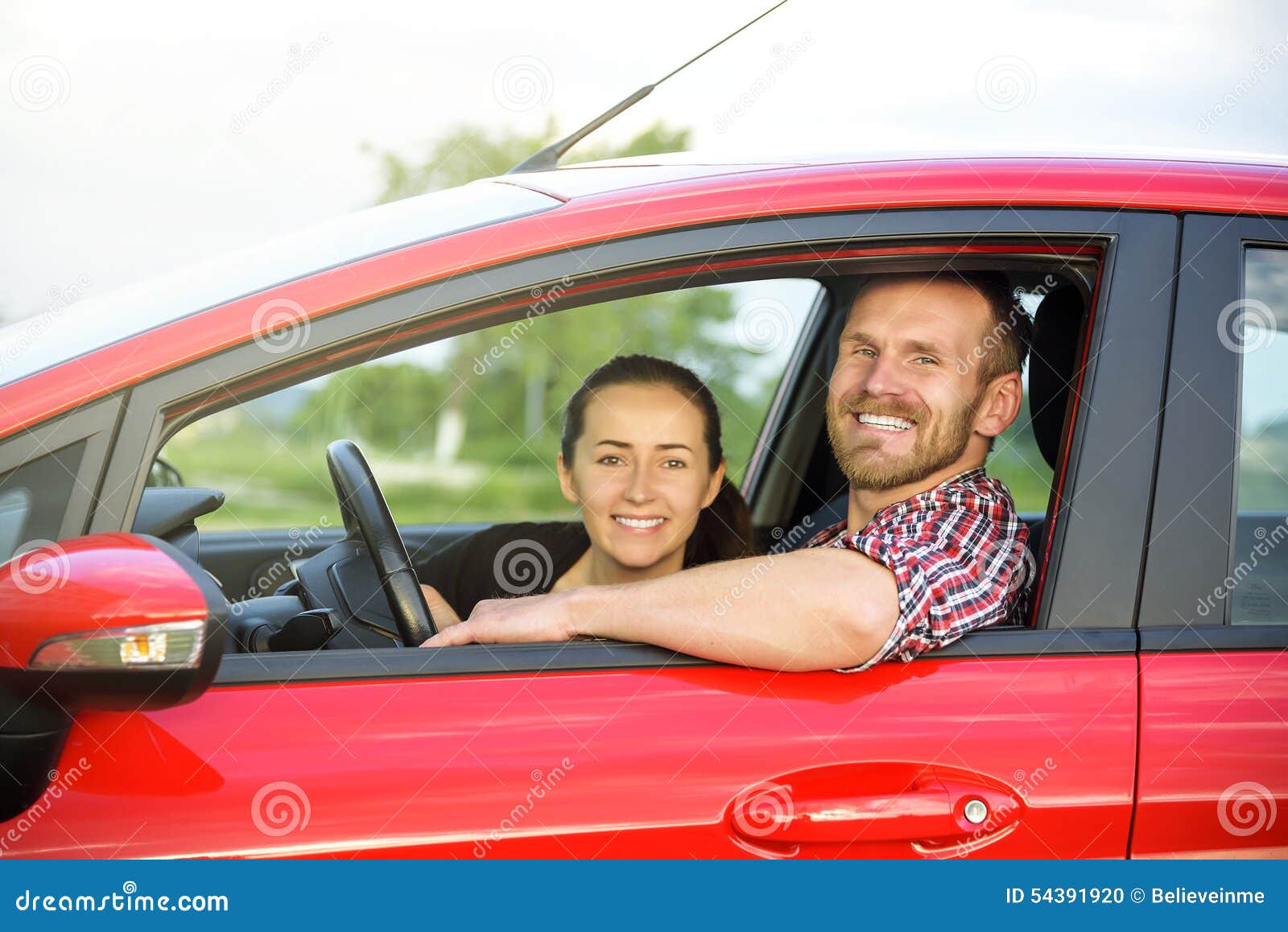 Couple in a red car stock photo. Image of street, family - 54391920