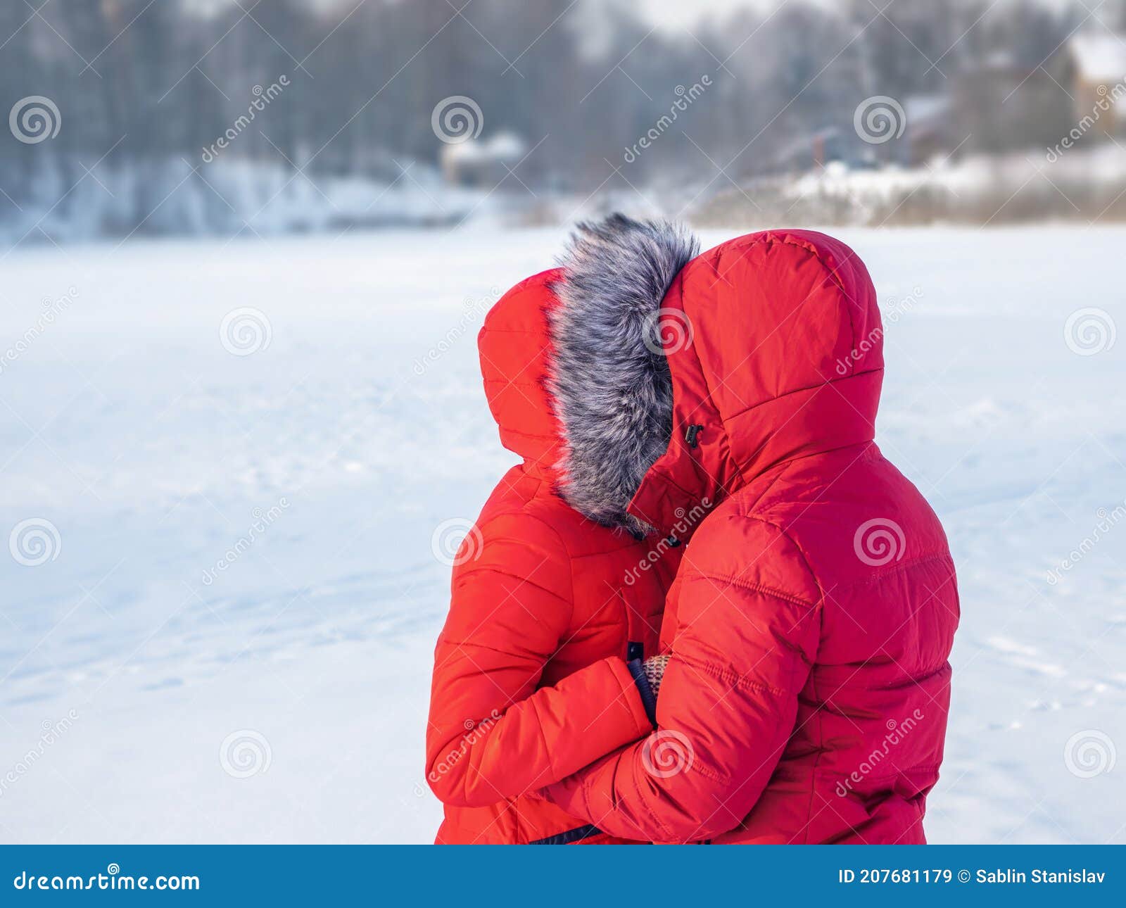 A Couple in Red Jackets in Winter Hug in the Cold Stock Image - Image ...