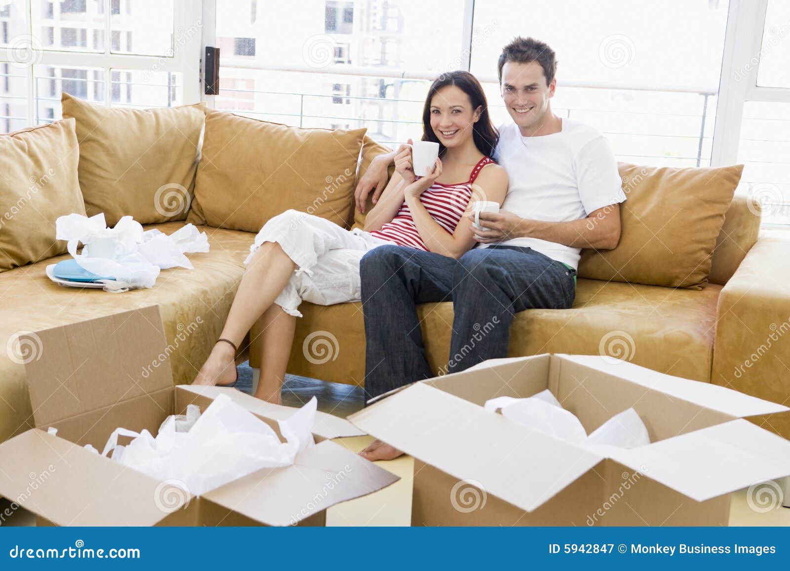 Couple Relaxing with Coffee by Boxes in New Home Stock Image - Image of ...
