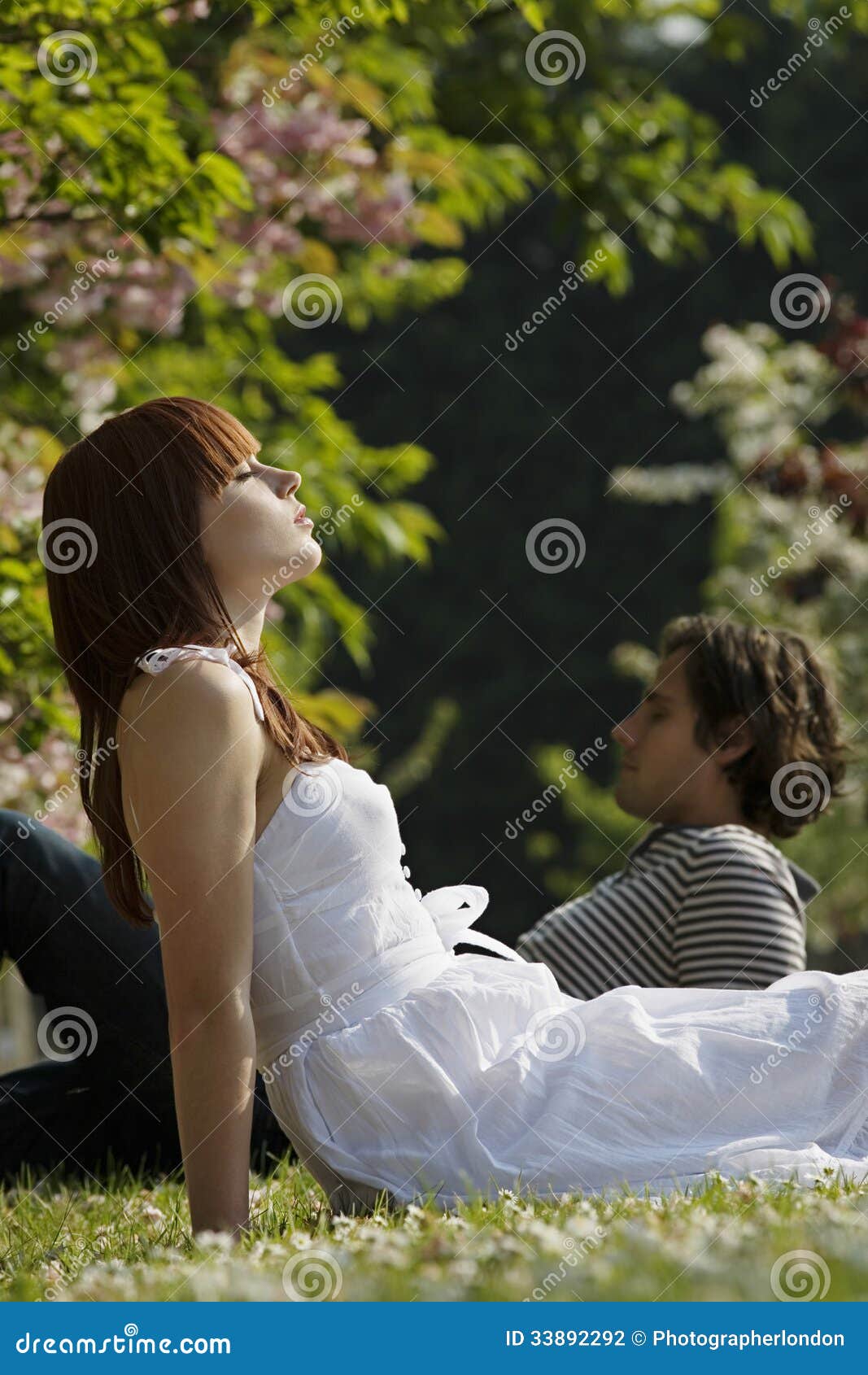 Couple Relaxing in Park stock photo. Image of outdoors - 33892292
