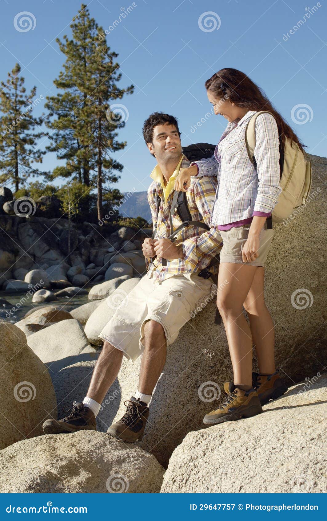 Couple Relaxing on Rocks stock image. Image of person - 29647757