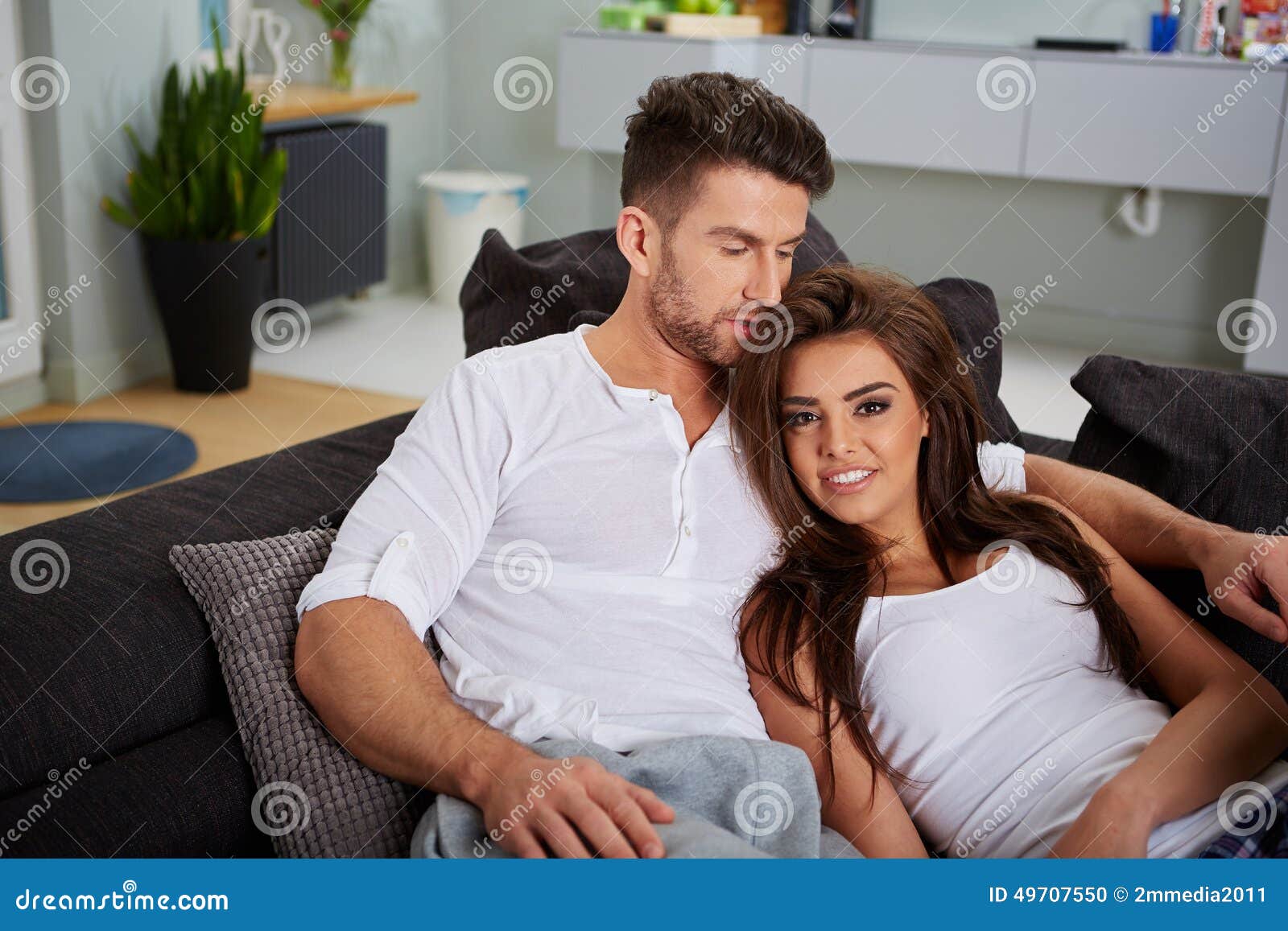 Couple relaxing on a sofa stock photo. Image of jolly - 49707550