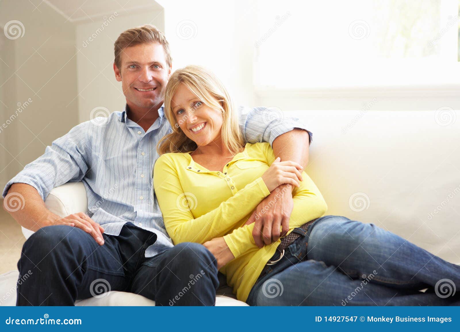 Couple Relaxing on Sofa at Home Stock Image - Image of lounge, room ...