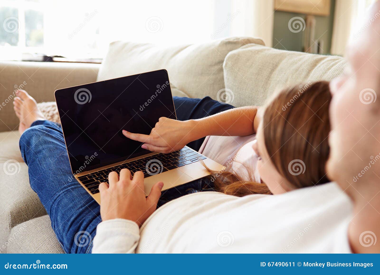 Couple Relaxing on Sofa Using Laptop Computer Together Stock Image ...