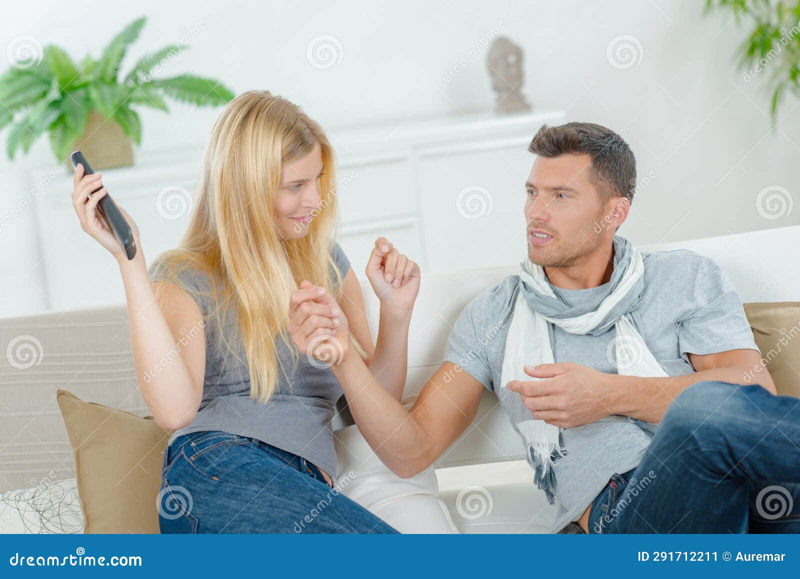 Couple with remote control stock image. Image of handsome - 291712211