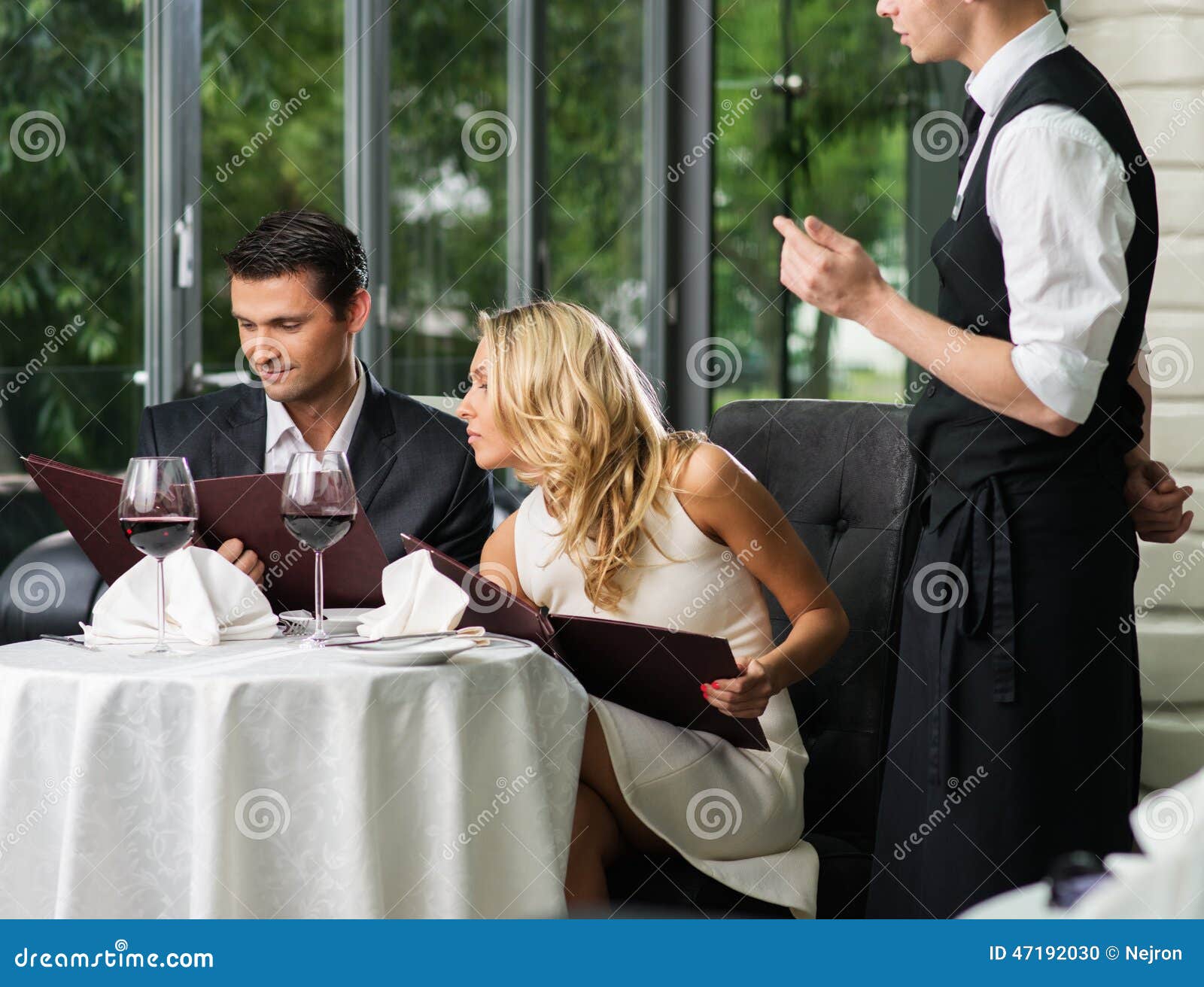 Couple in a Restaurant Making Order Stock Photo - Image of drink, carte ...