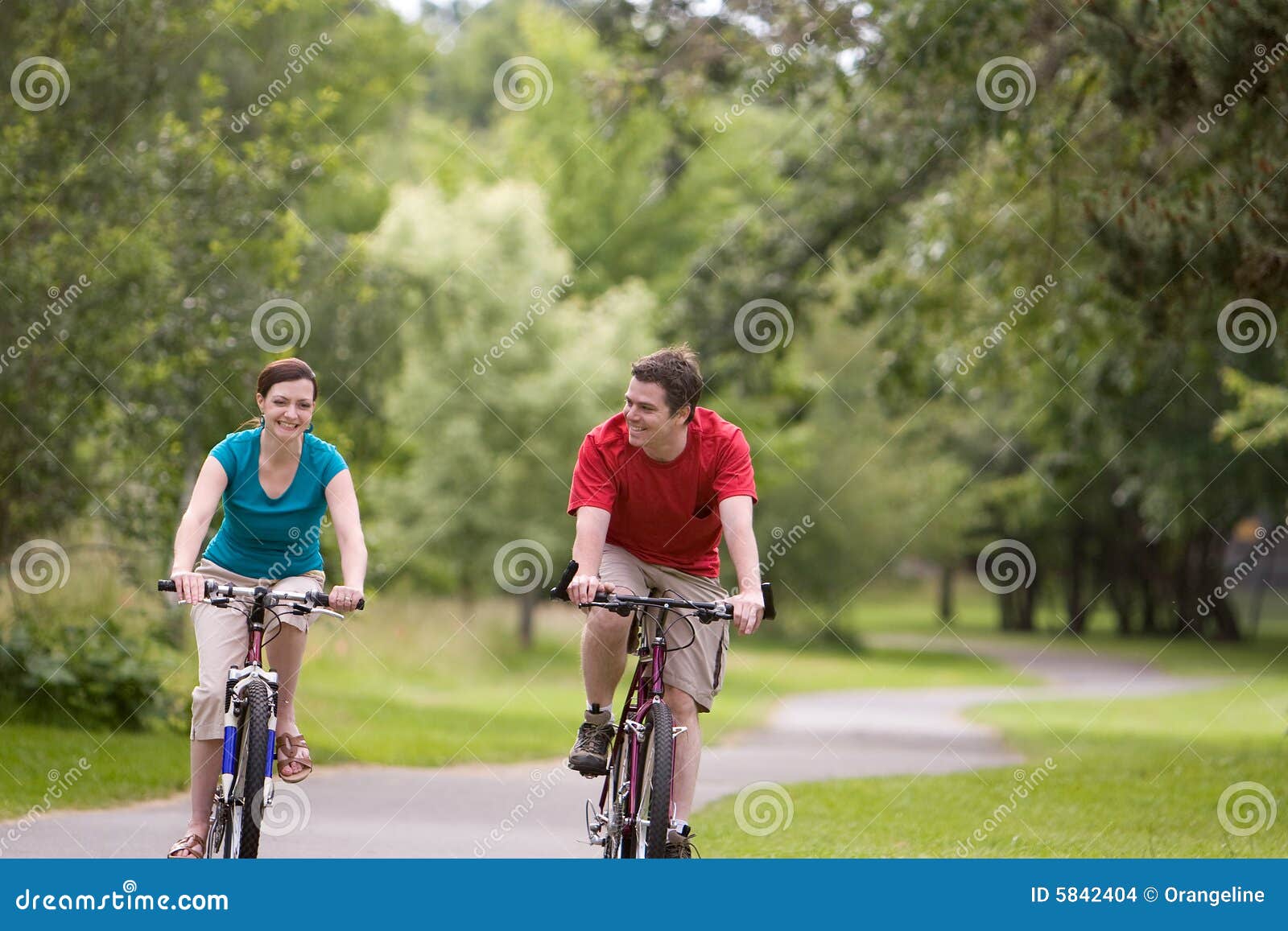 Couple Riding Bicycles at Park - Horizontal Stock Photo - Image of ...
