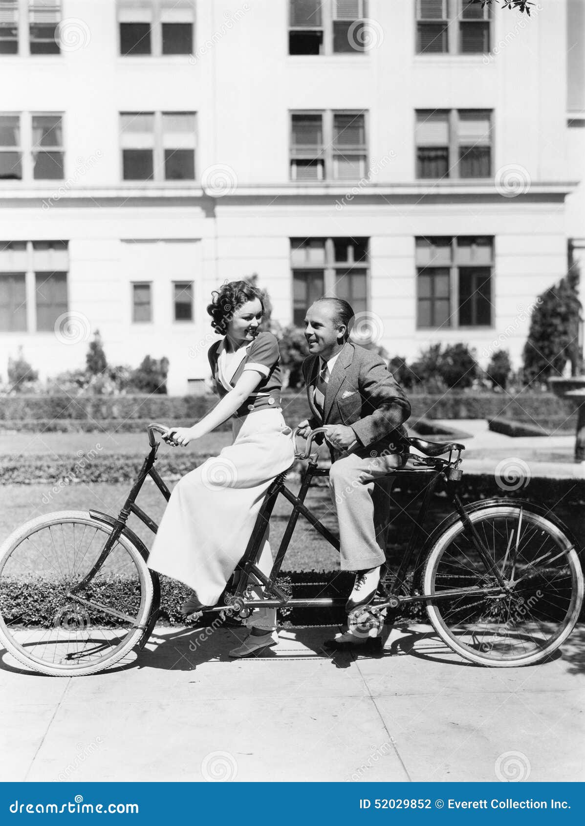 Couple riding tandem bike stock photo. Image of curls - 52029852