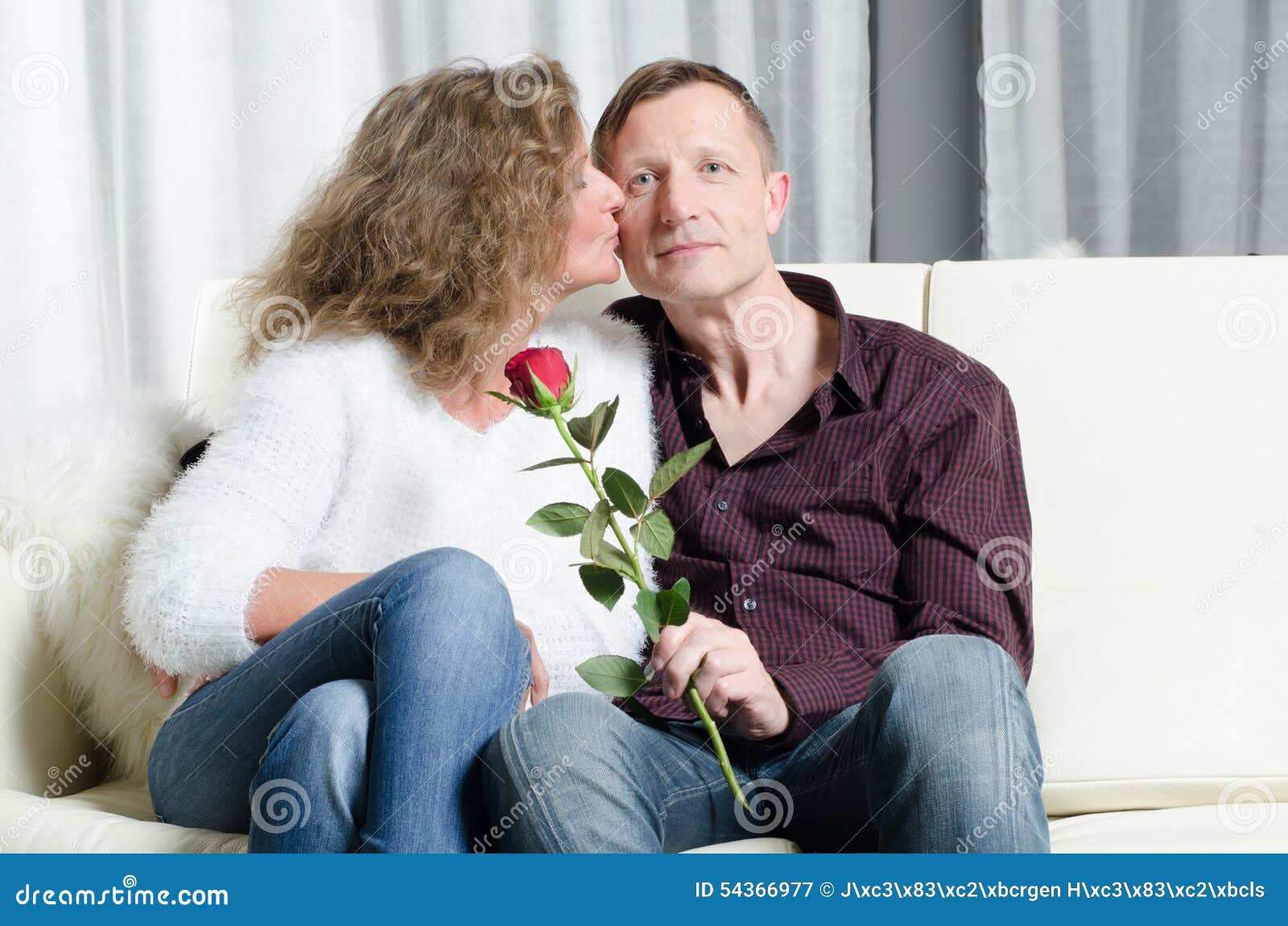 Couple with Rose Kissing on Couch Stock Image - Image of laughing ...