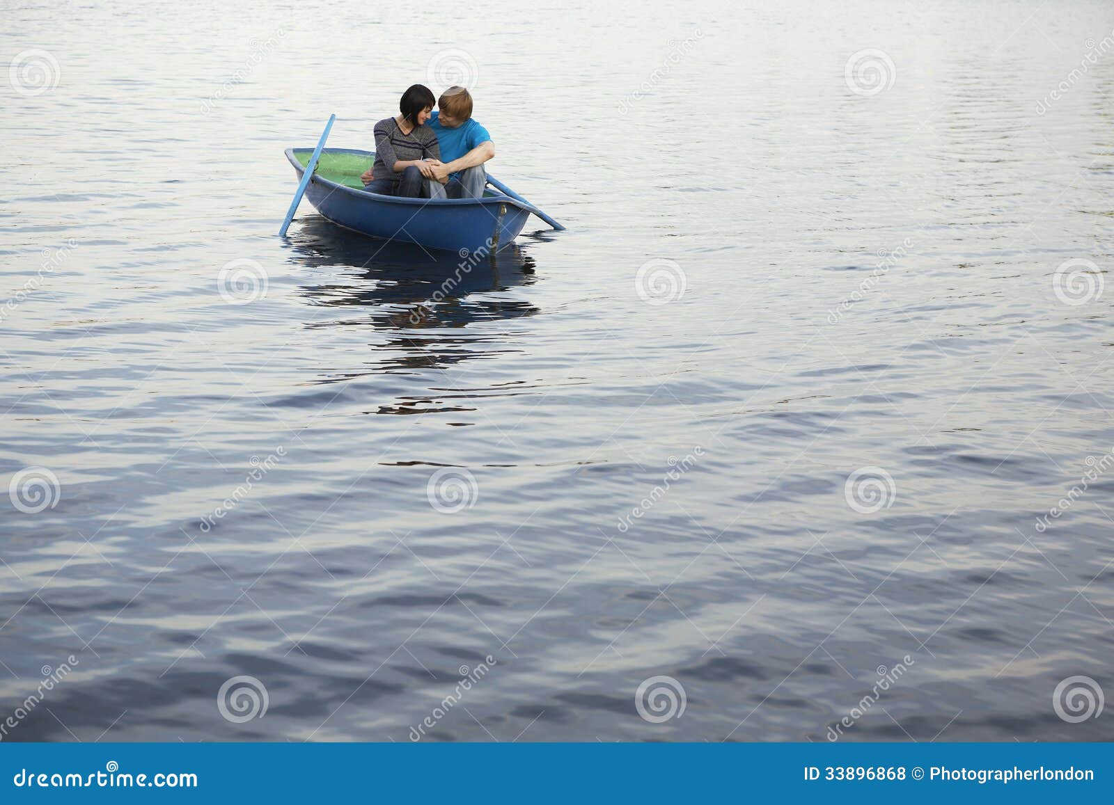 Couple in Rowboat at Lake stock photo. Image of embracing - 33896868