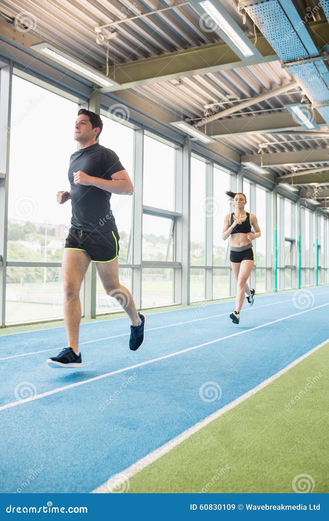 Couple Running on the Indoor Track Stock Image - Image of holding, body ...