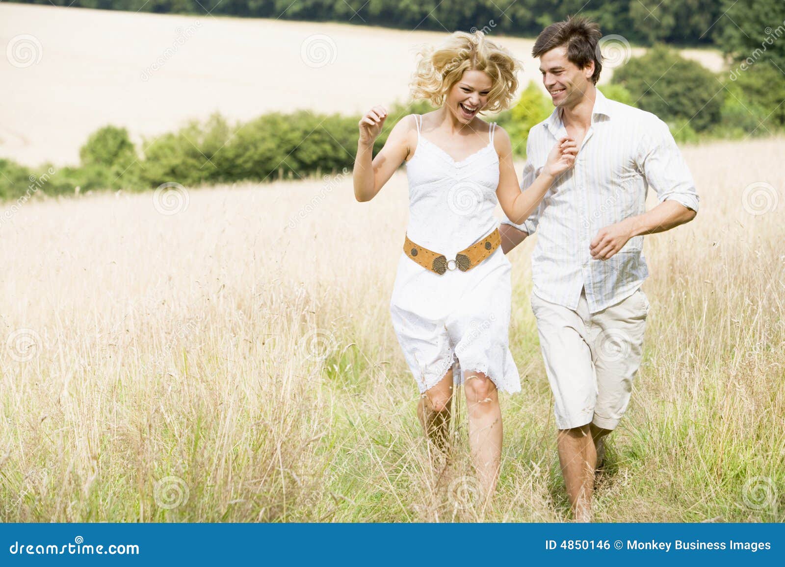 Couple Running through Summer Field Stock Photo - Image of playing ...