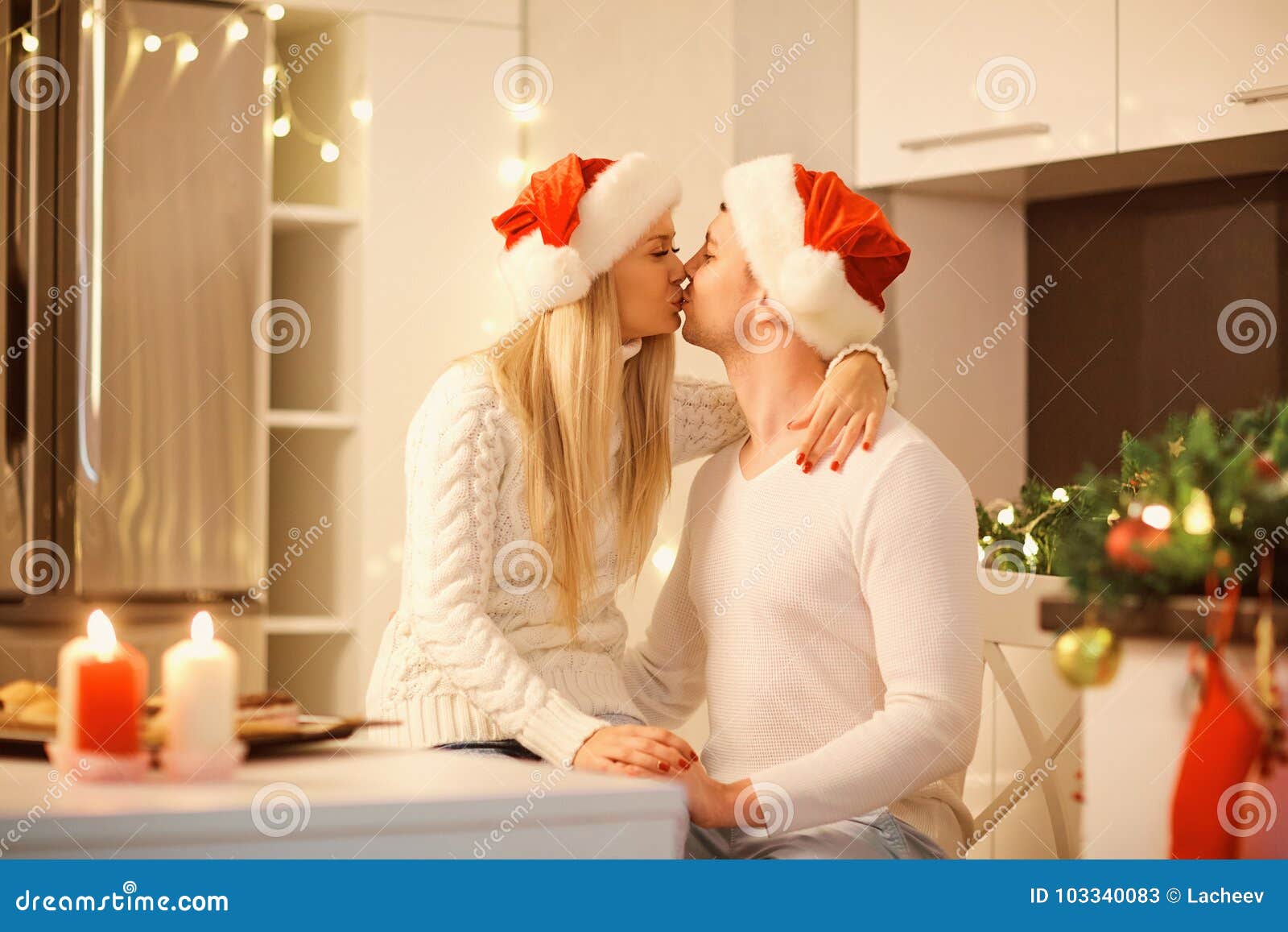 A Couple in Santa Claus Hats Kisses on Christmas Day. Stock Image ... A Couple in Santa Claus Hats Kisses on Christmas Day. Stock Image ...