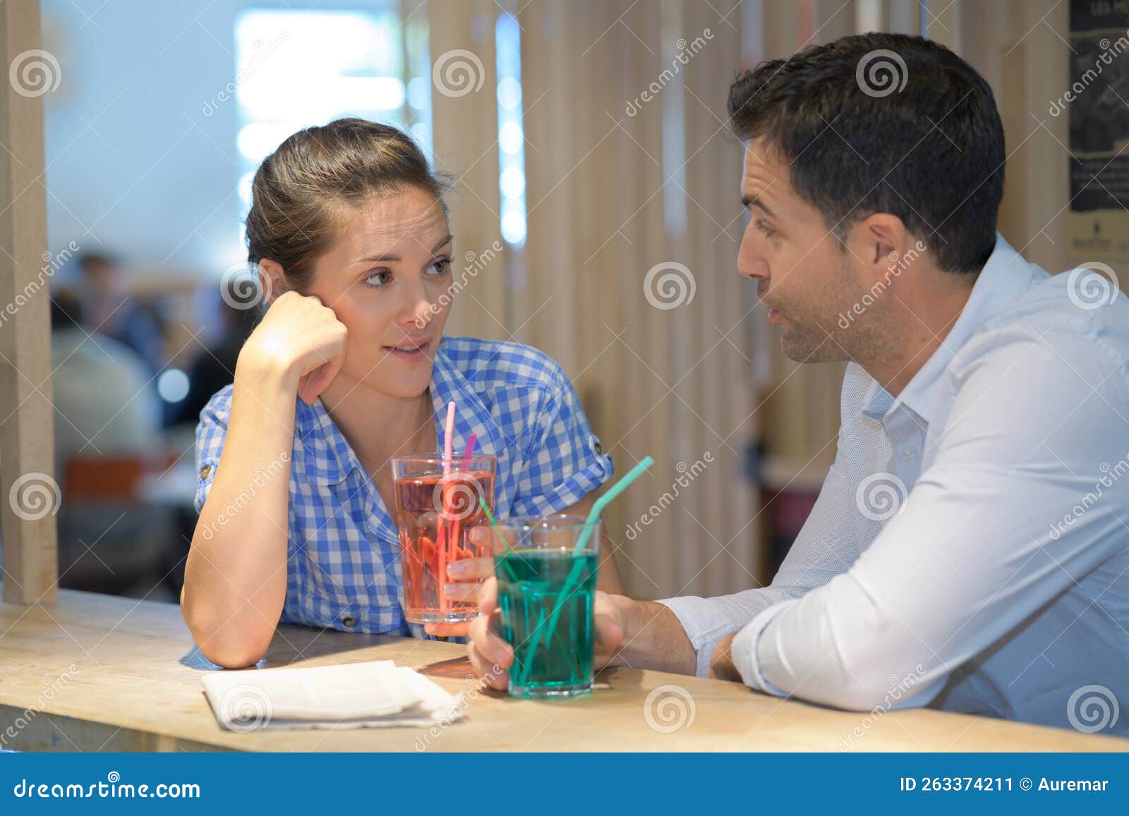 Couple Sat Chatting at Bar with Drinks Stock Image - Image of ...