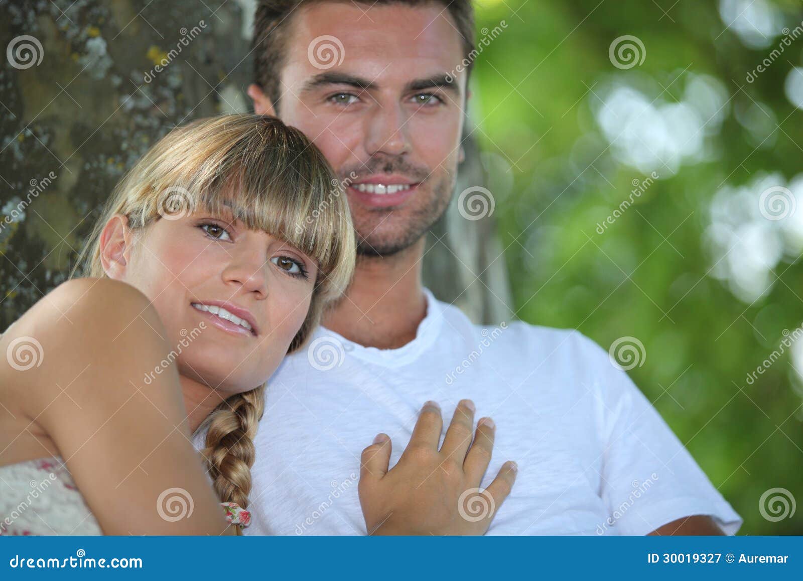 Couple sat by a tree stock image. Image of affection - 30019327