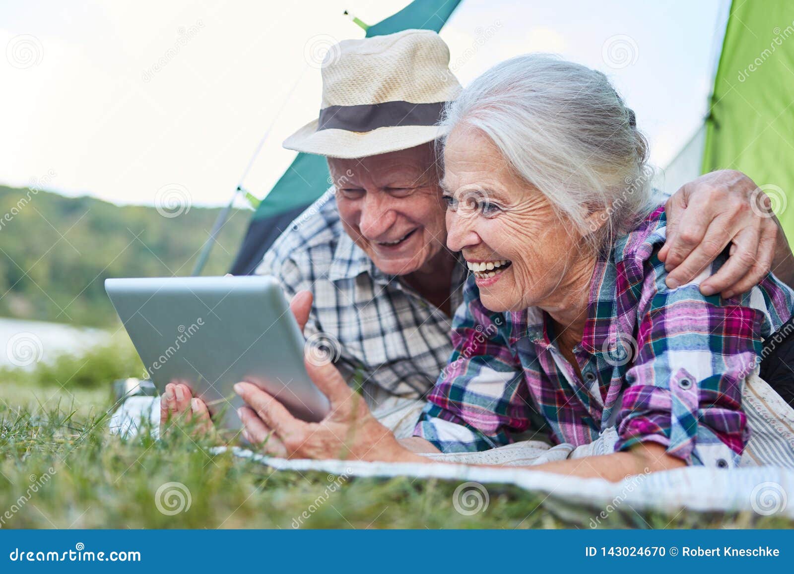 Couple of Seniors Using Tablet Computer while Camping Stock Photo ...