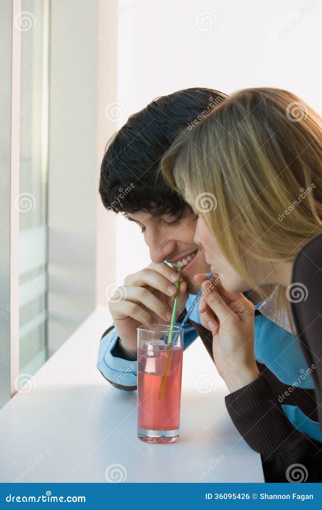 A couple sharing a drink stock photo. Image of female - 36095426