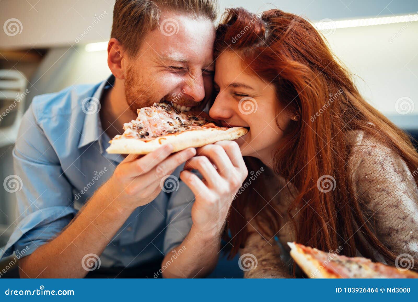 Couple Sharing Pizza and Eating Stock Photo - Image of feeding, kitchen ...