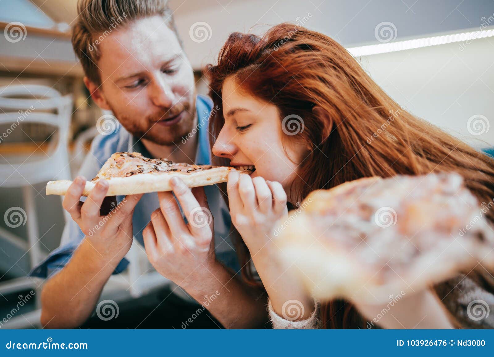 Couple Sharing Pizza and Eating Stock Photo - Image of eating, adult ...