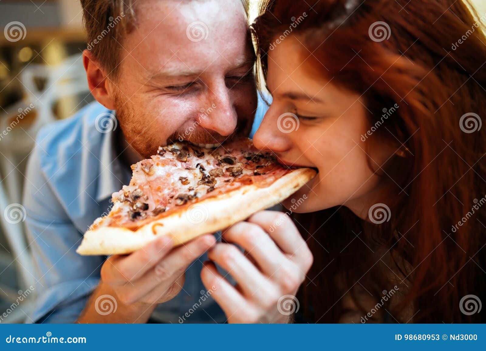 Couple Sharing Pizza and Eating Stock Image - Image of lunch, carefree ...