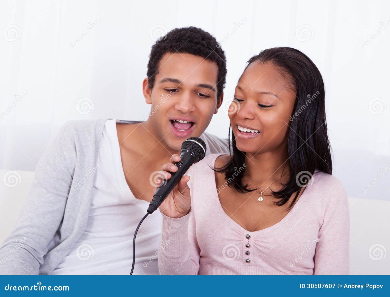 Couple Singing with Microphone Stock Image - Image of casual, indoor ...