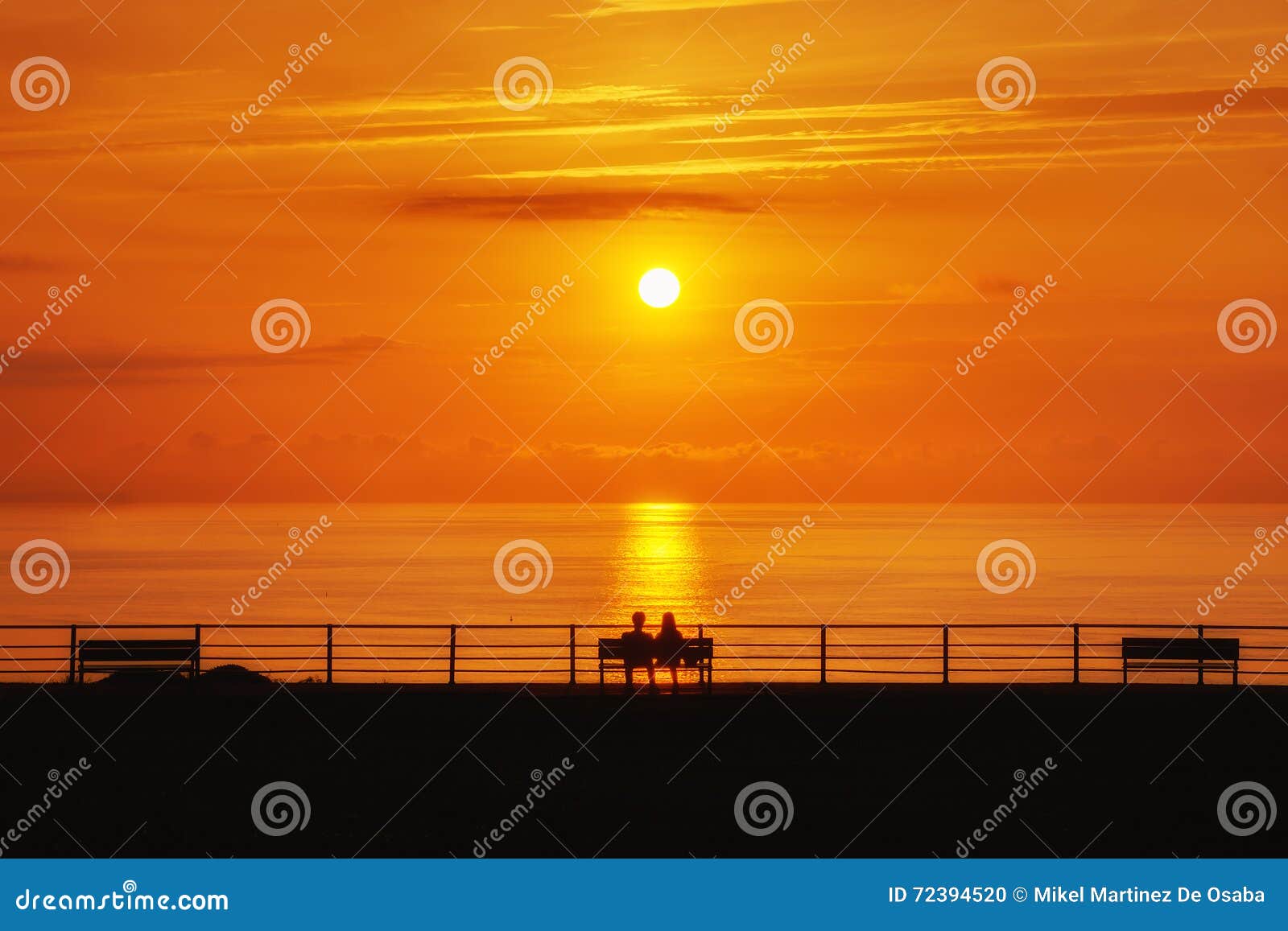 Couple Sitting on Bench Watching the Sunset Stock Photo - Image of seat ...