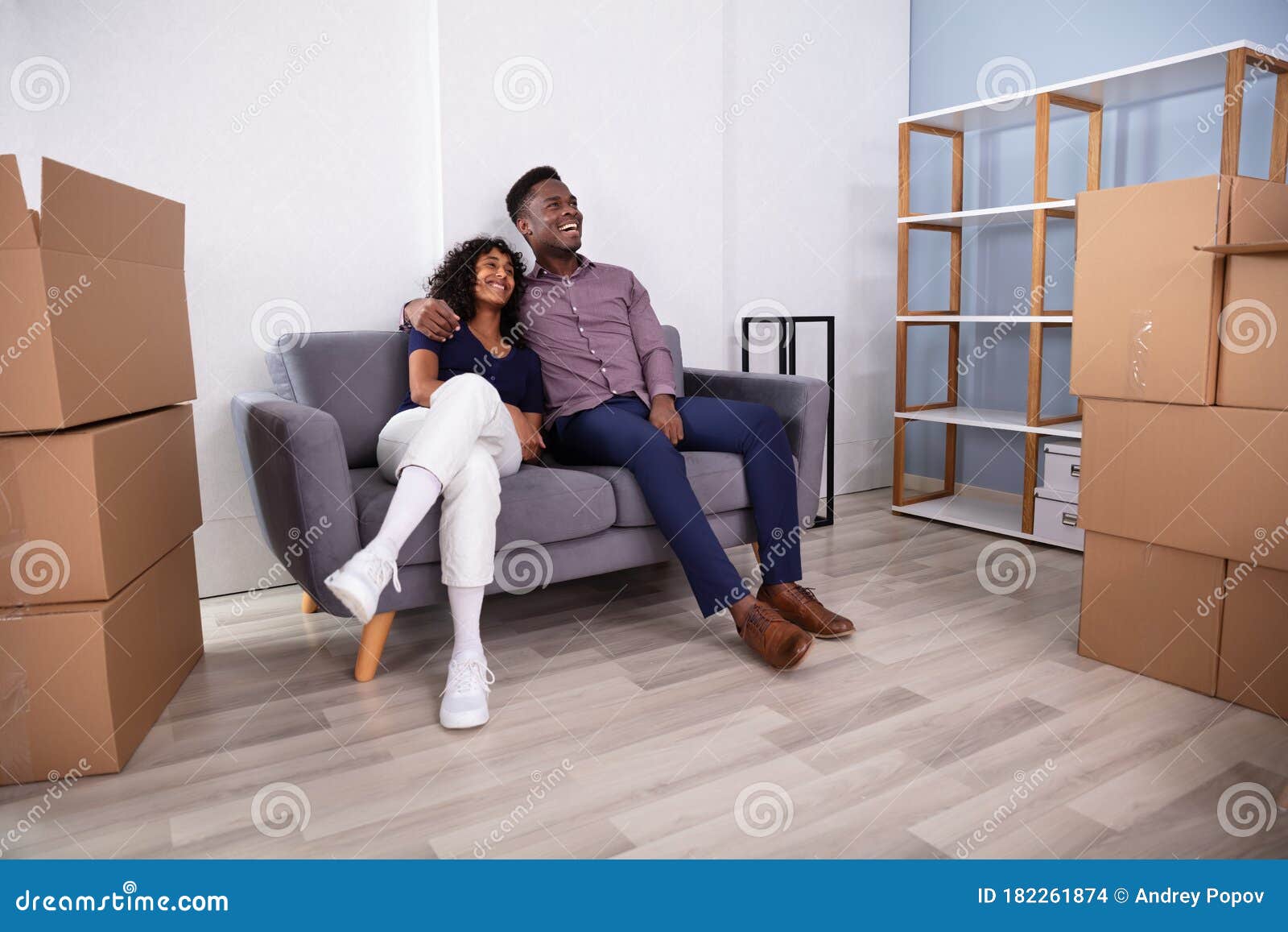 Couple Sitting on Couch Inside Their New Home Stock Photo - Image of ...