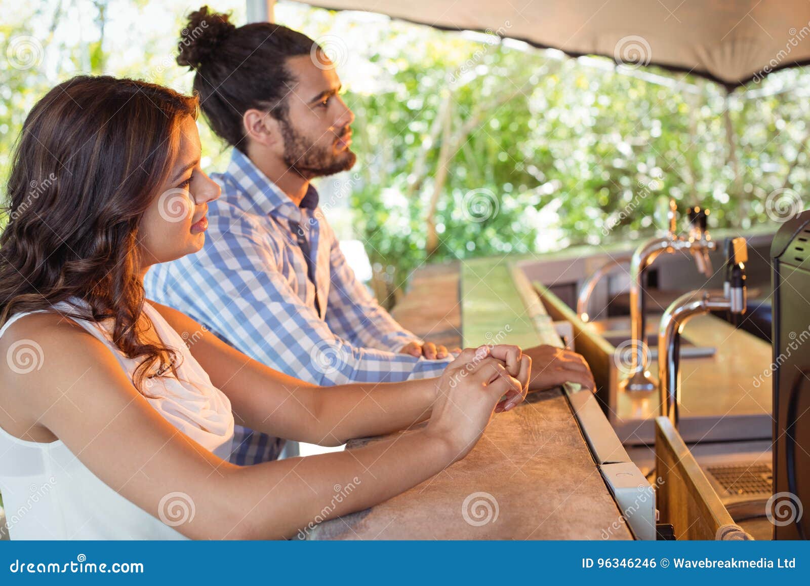 Couple sitting at counter stock photo. Image of leisure - 96346246