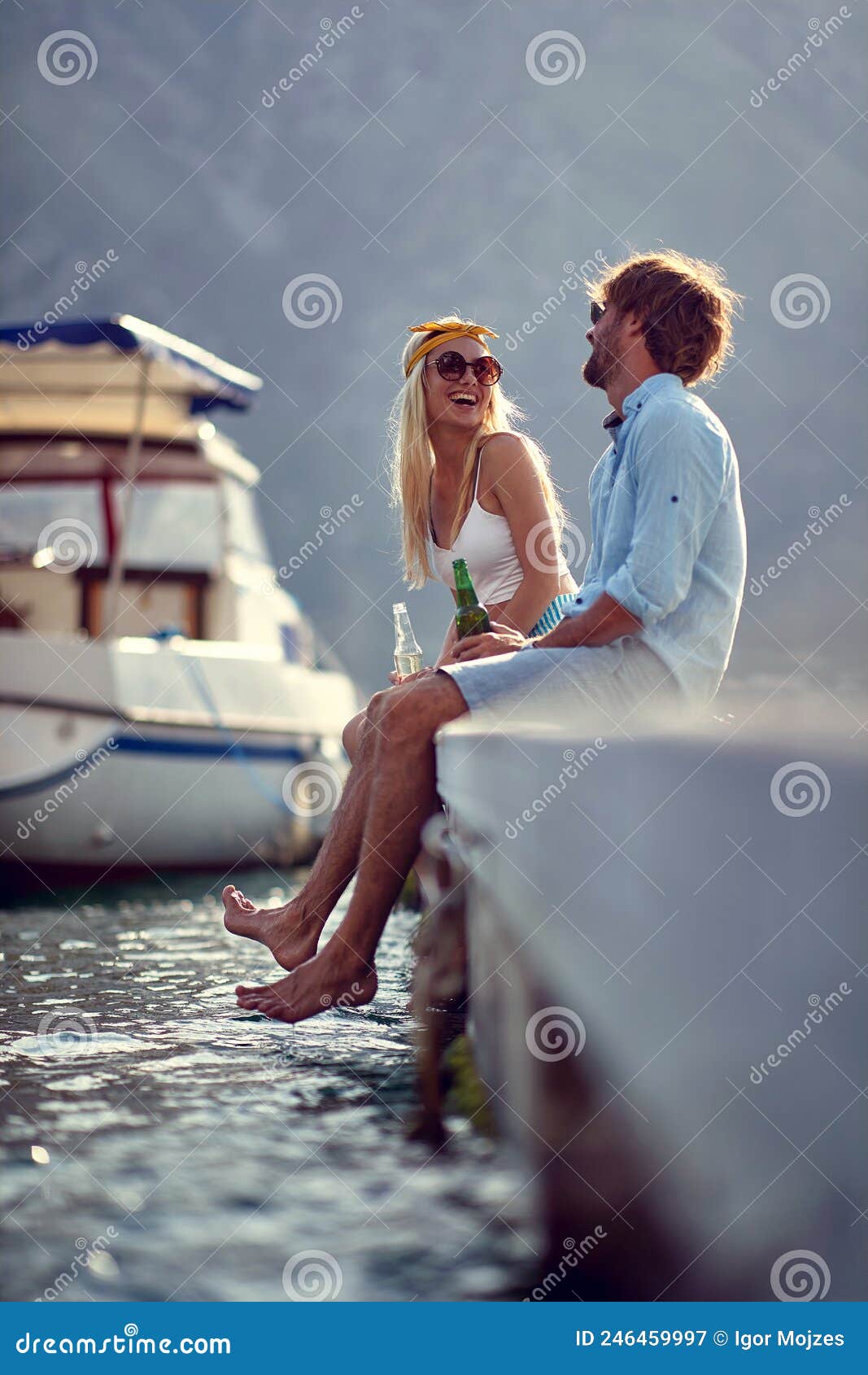Couple Sitting on the Dock and Drinking Beer Stock Image - Image of ...