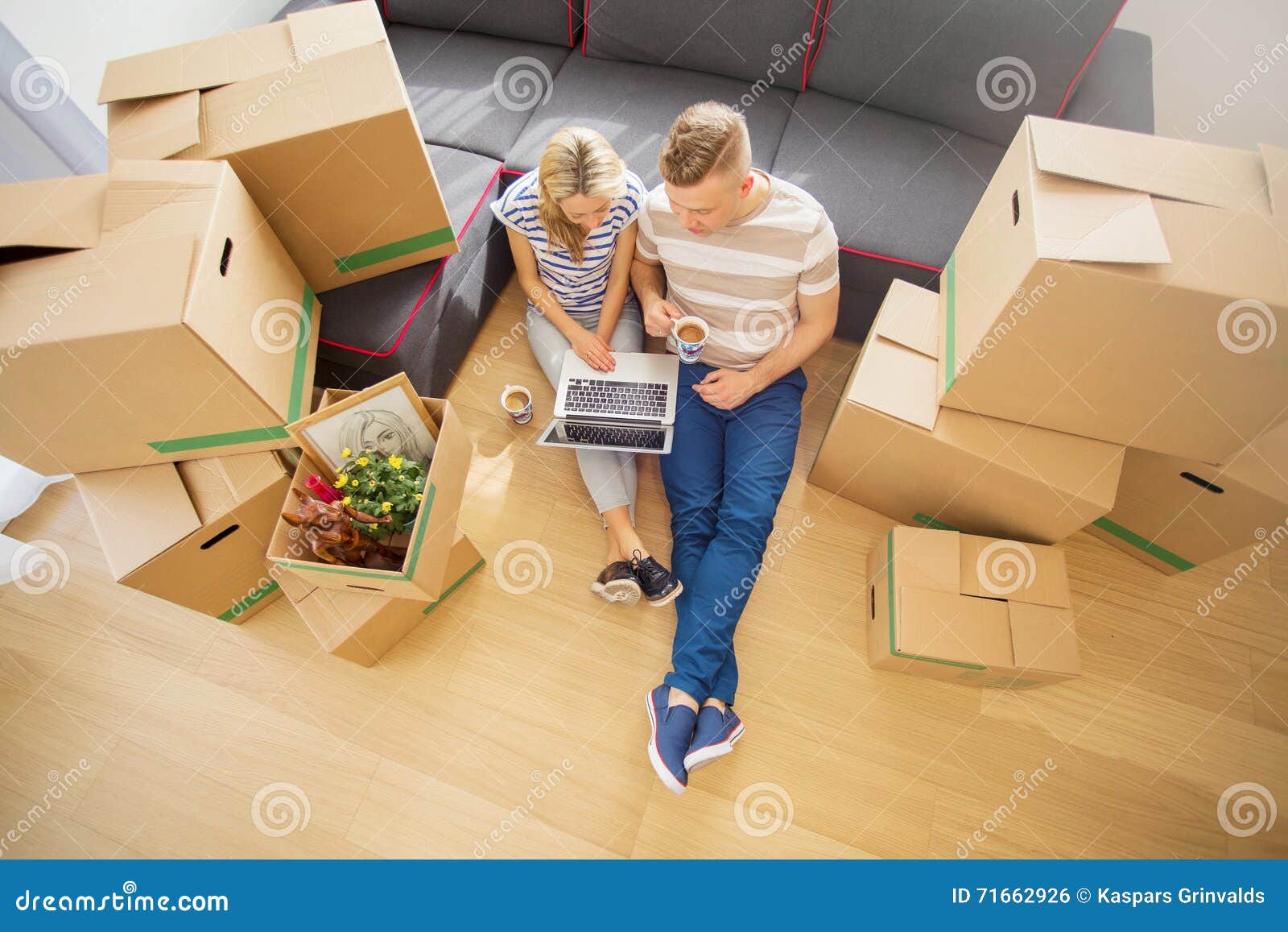 Couple Sitting on Floor Surrounded with Moving Boxes Stock Photo ...