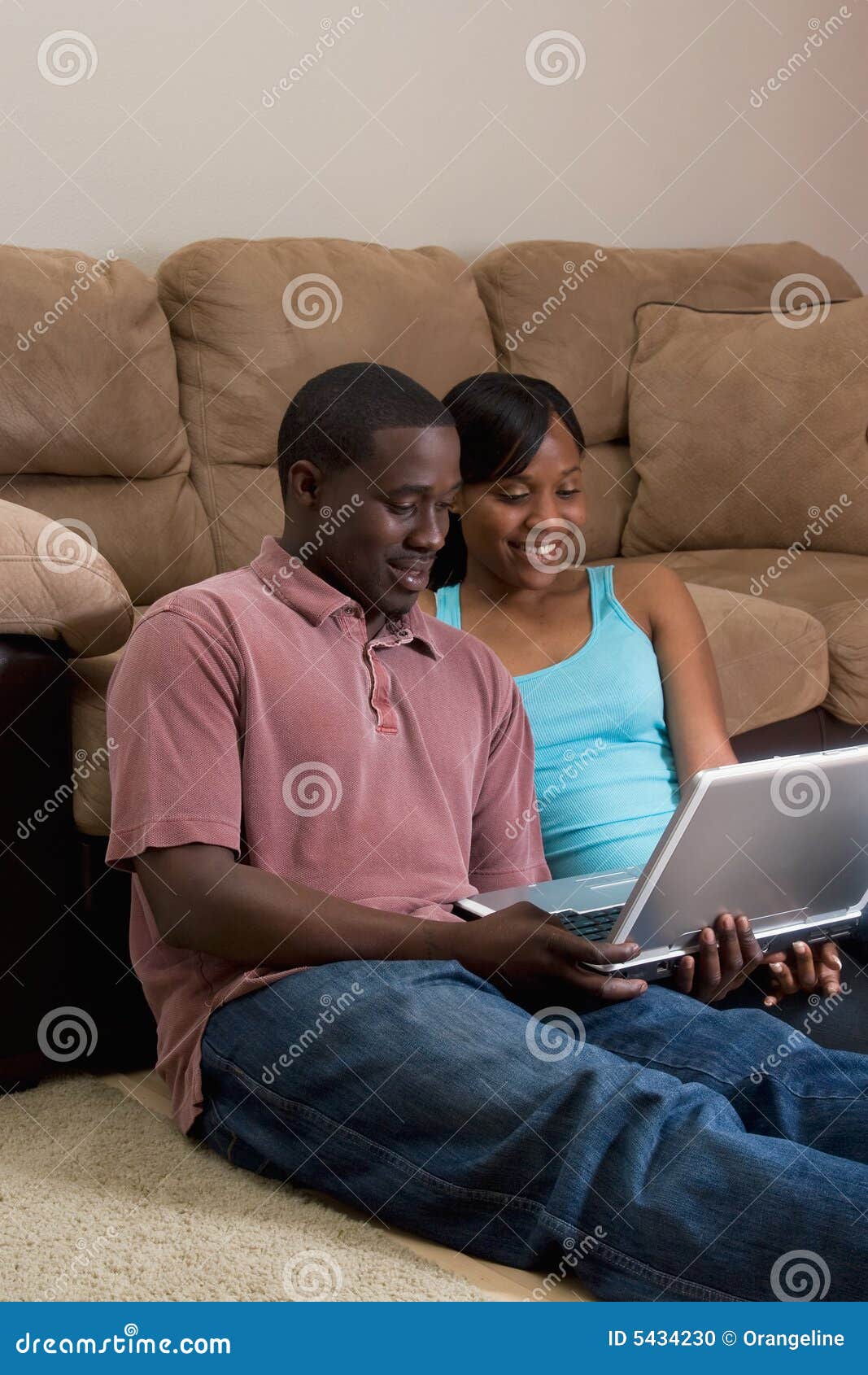 Couple Sitting in Front of Couch with Laptop Com Stock Photo - Image of ...