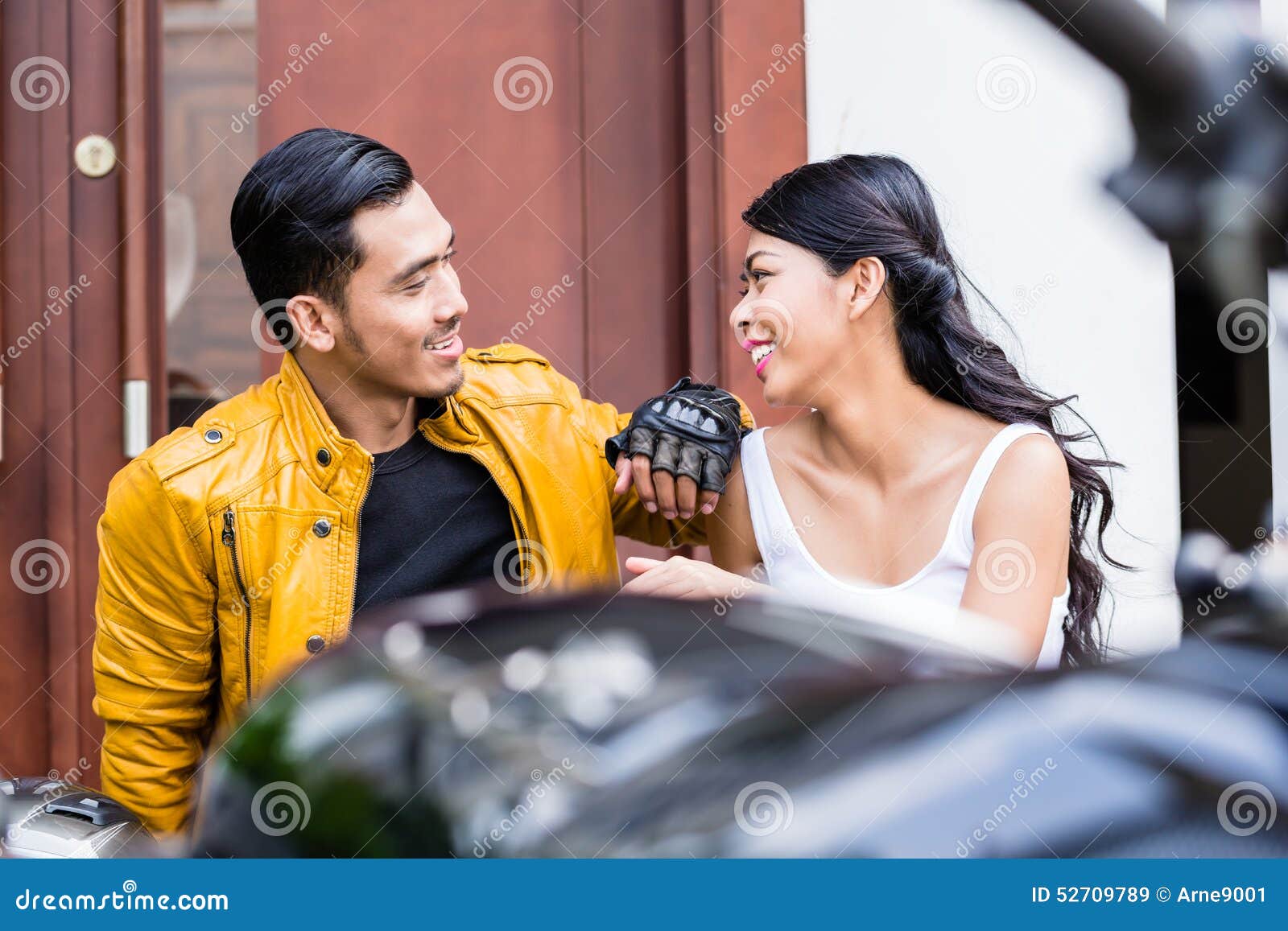 Couple Sitting in Front of House with Motorcycle Stock Image - Image of ...
