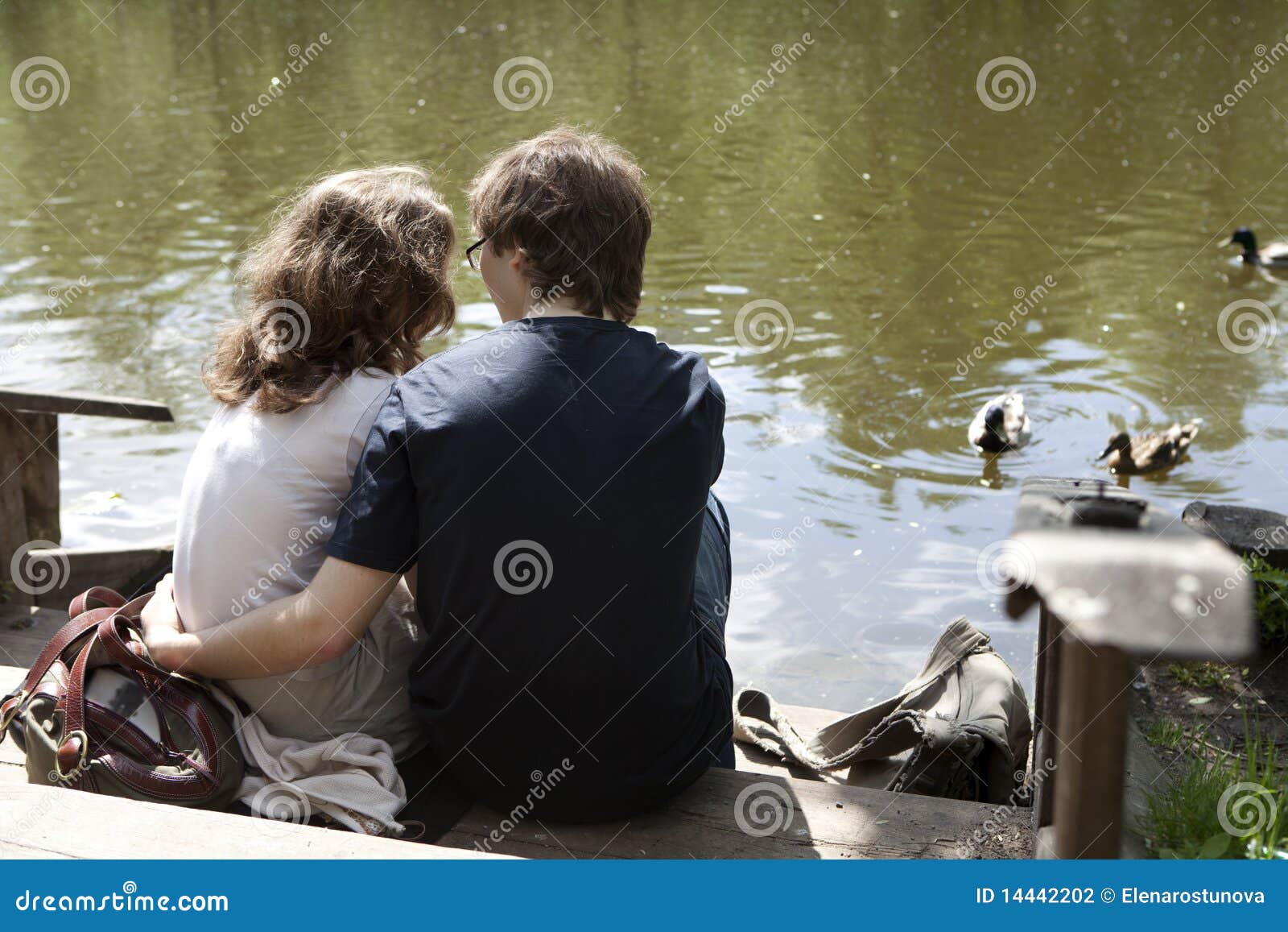 A Couple Sitting Near River Stock Photo - Image of lake, lovers: 14442202