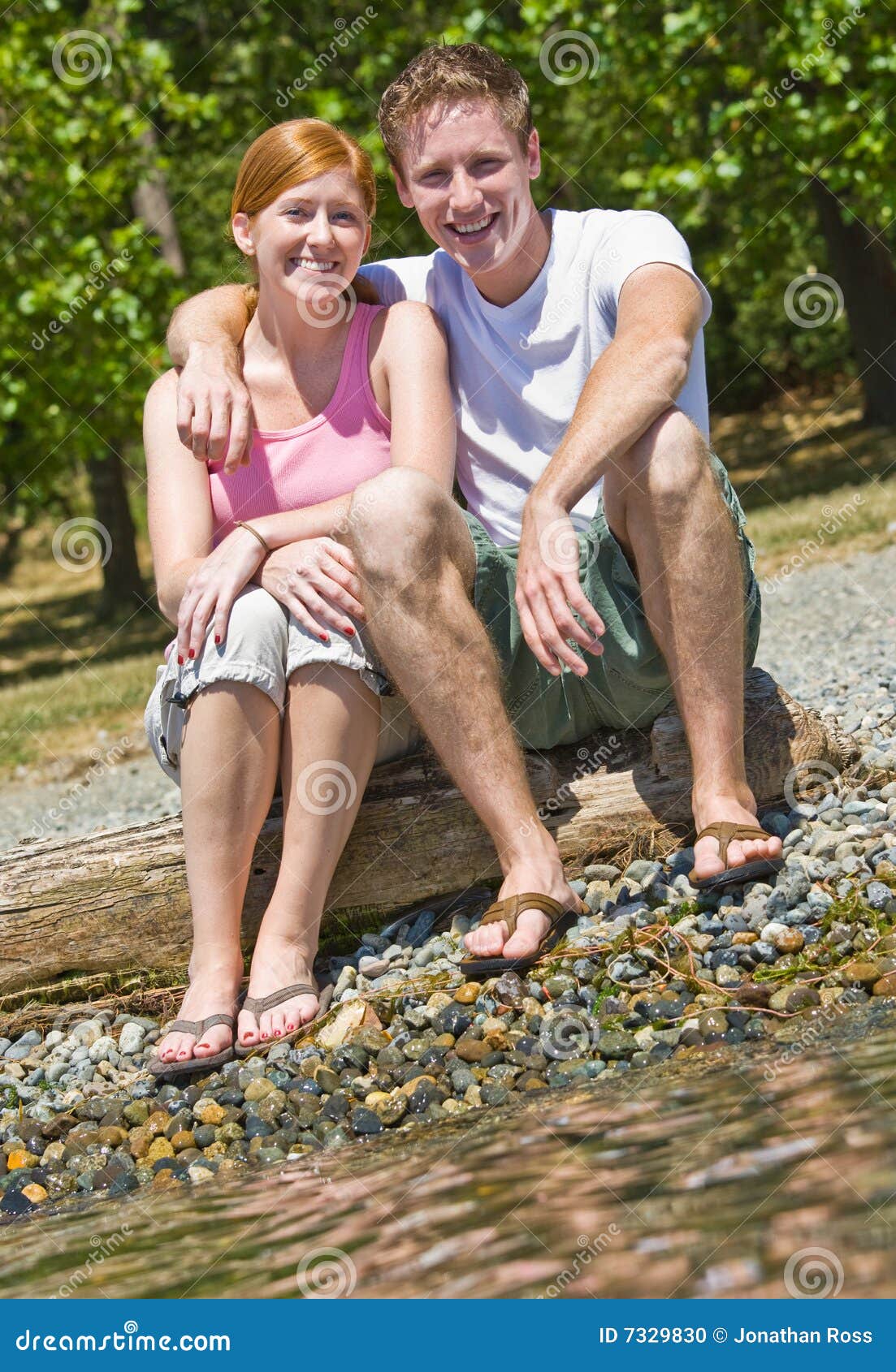Couple sitting near stream stock photo. Image of riverside - 7329830